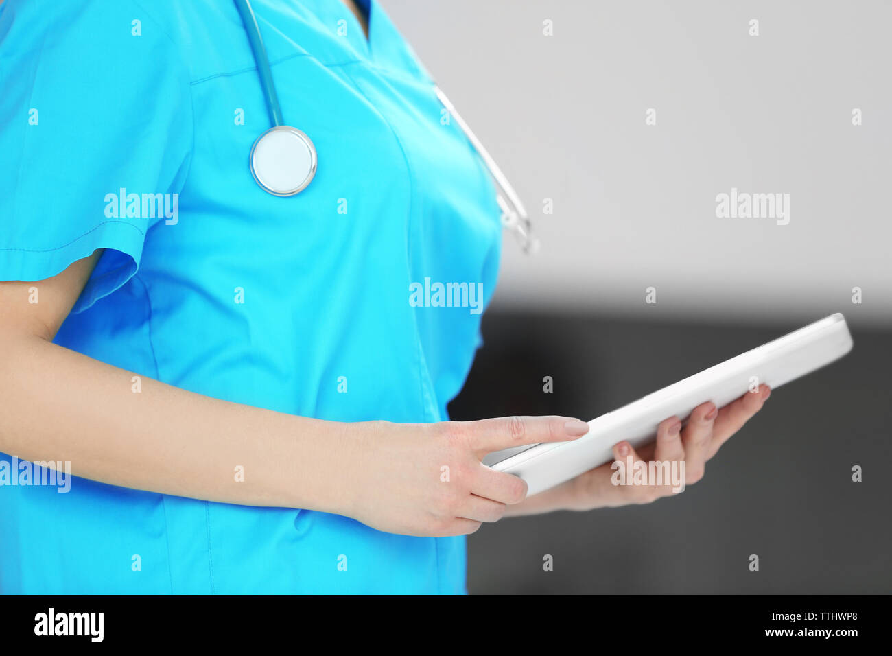 Female doctor holding tablet, close-up Stock Photo - Alamy