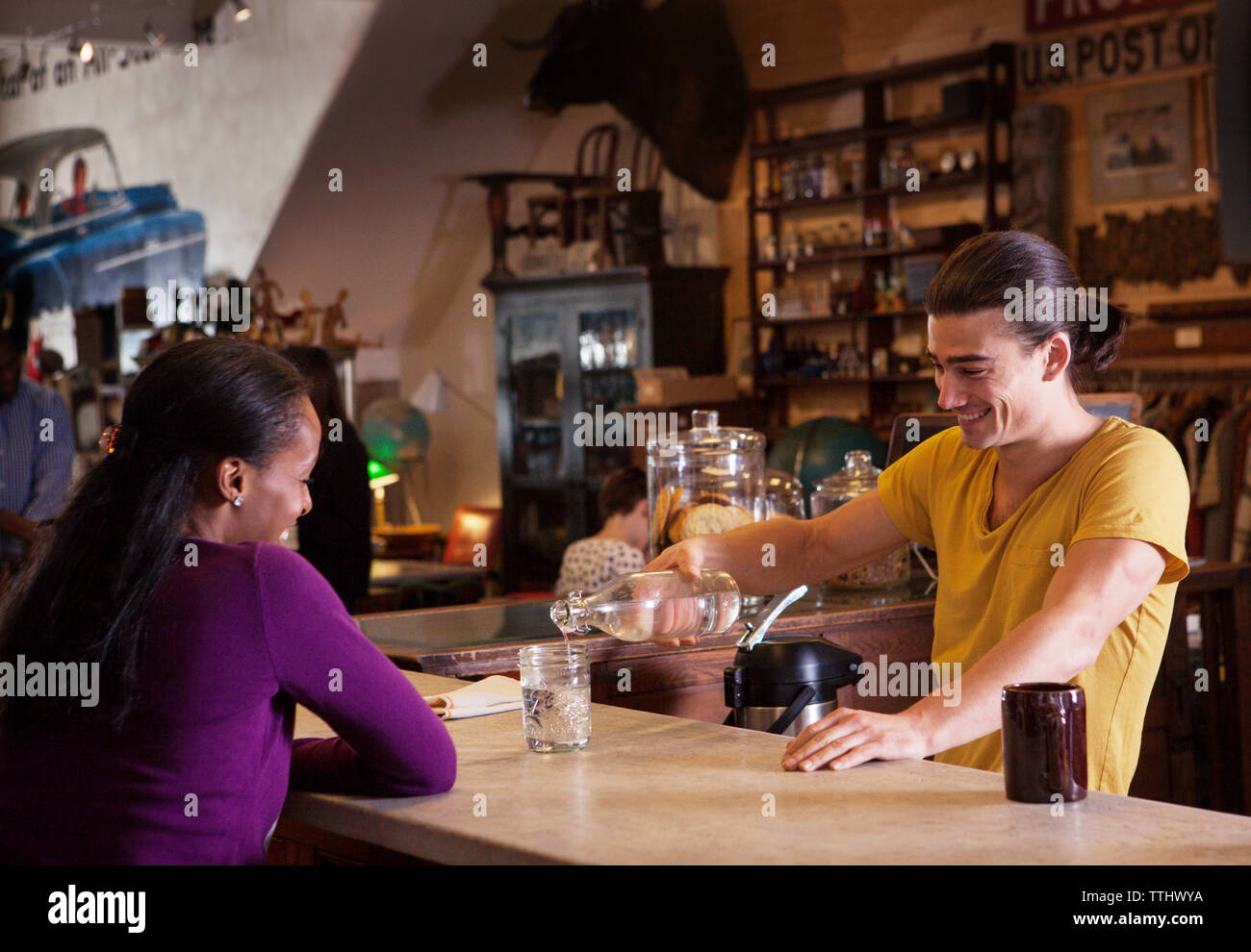 Male owner pouring drink for customer at cafe Stock Photo - Alamy