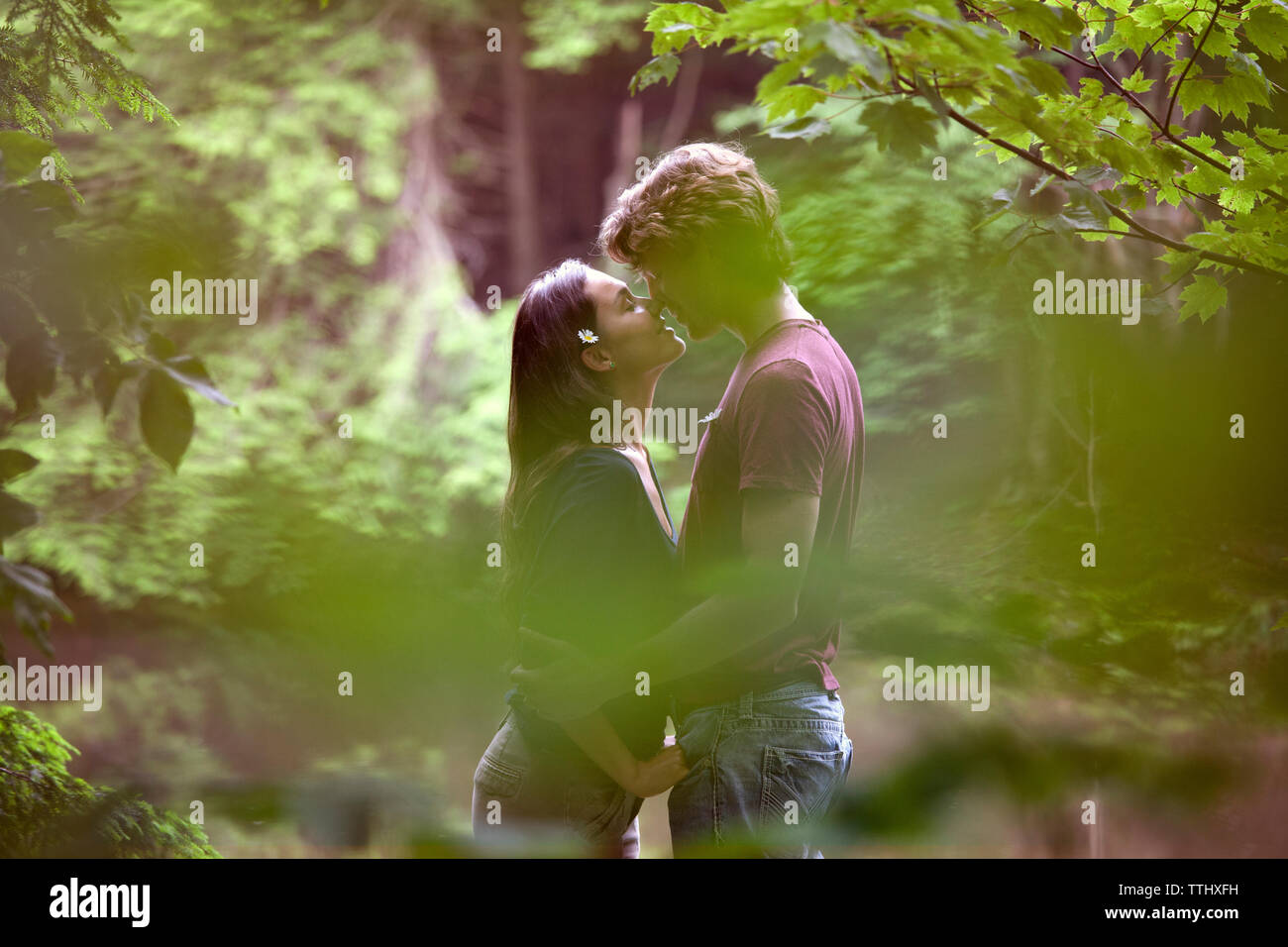 Side view of couple standing face to face Stock Photo - Alamy