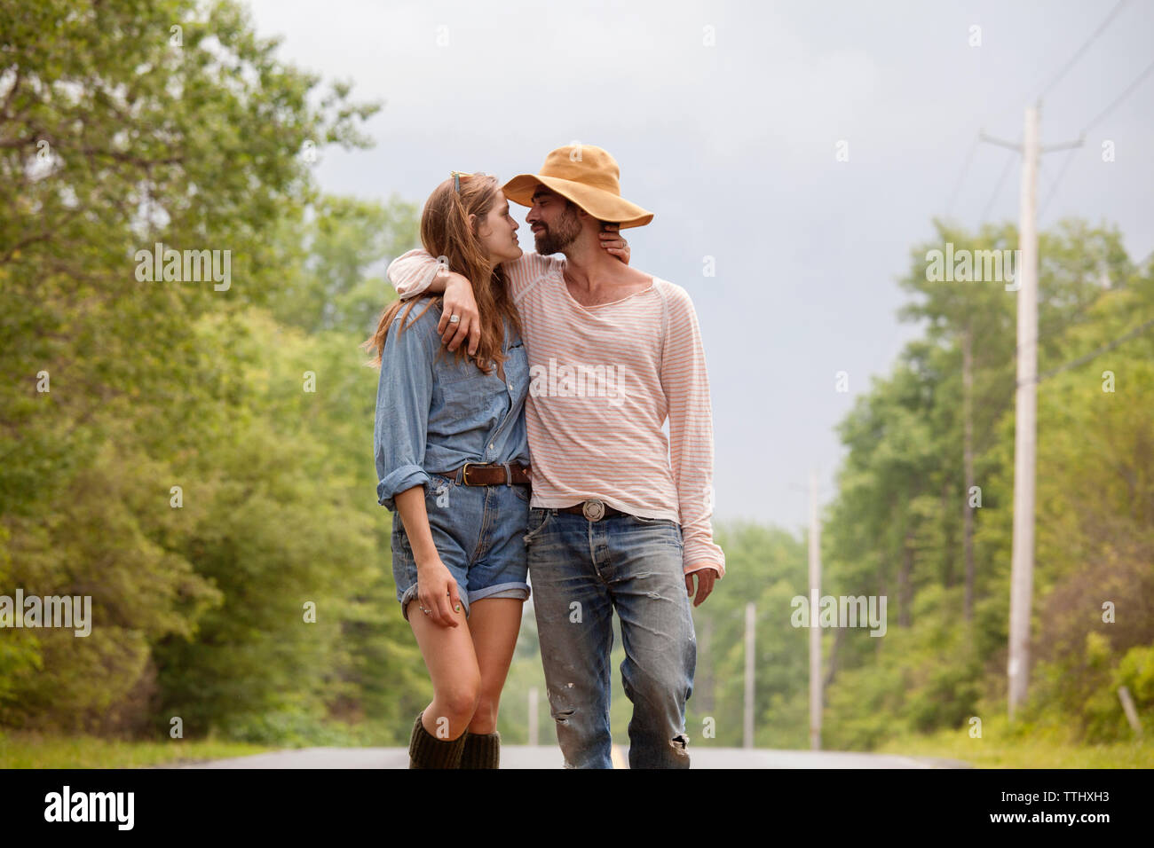 Man walking arm around woman hi-res stock photography and images - Alamy