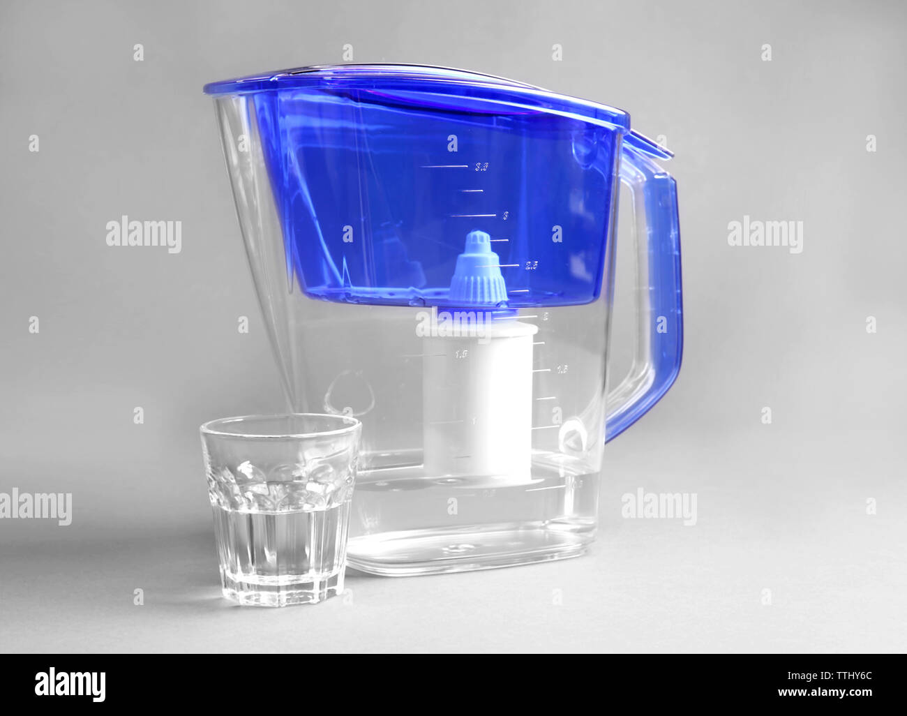 Water filter jug and a glass on the grey background Stock Photo - Alamy