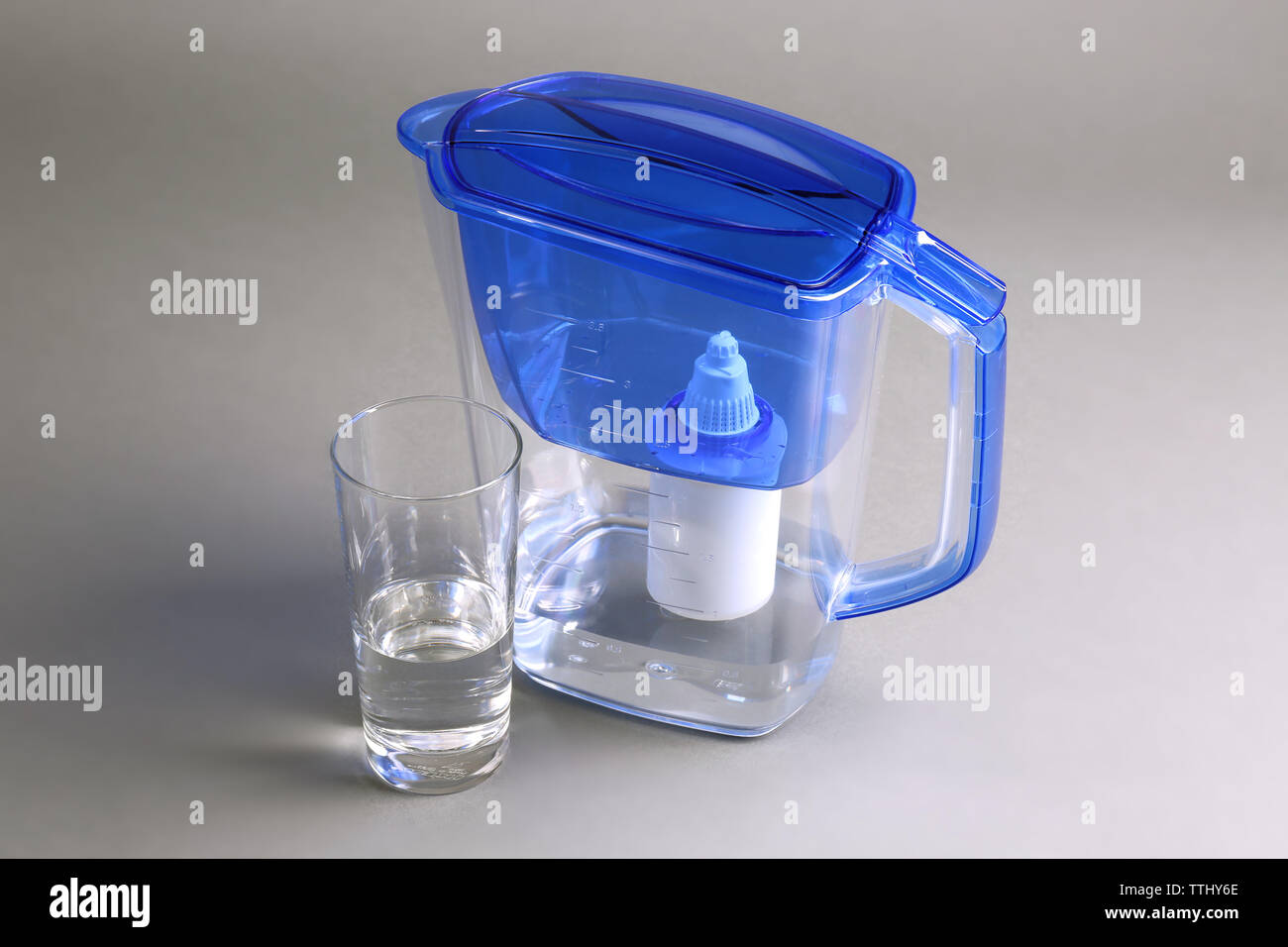 Water filter jug and a glass on the grey background Stock Photo - Alamy
