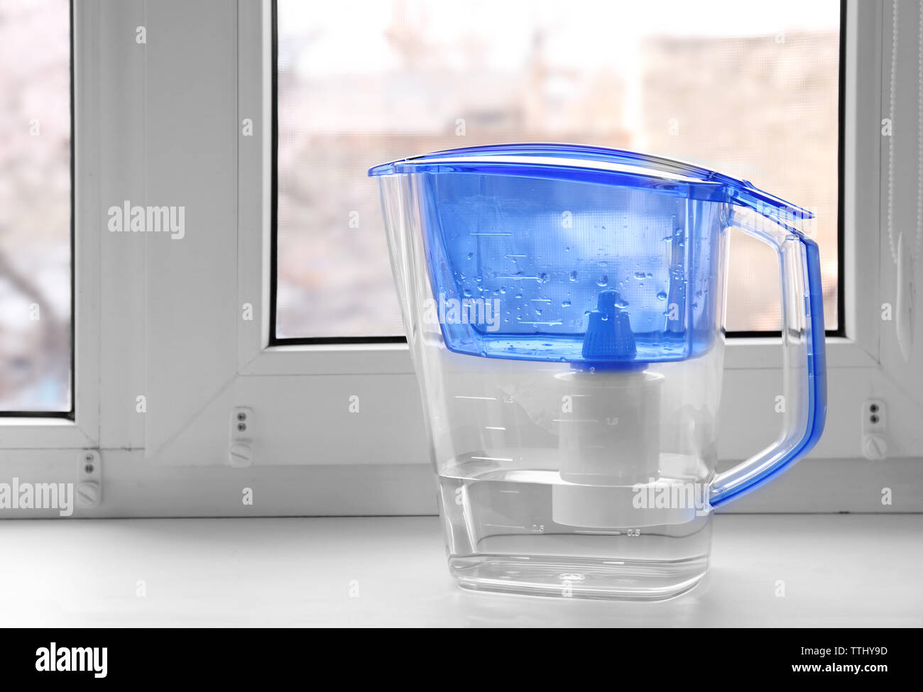 Water filter jug on the windowsill Stock Photo - Alamy