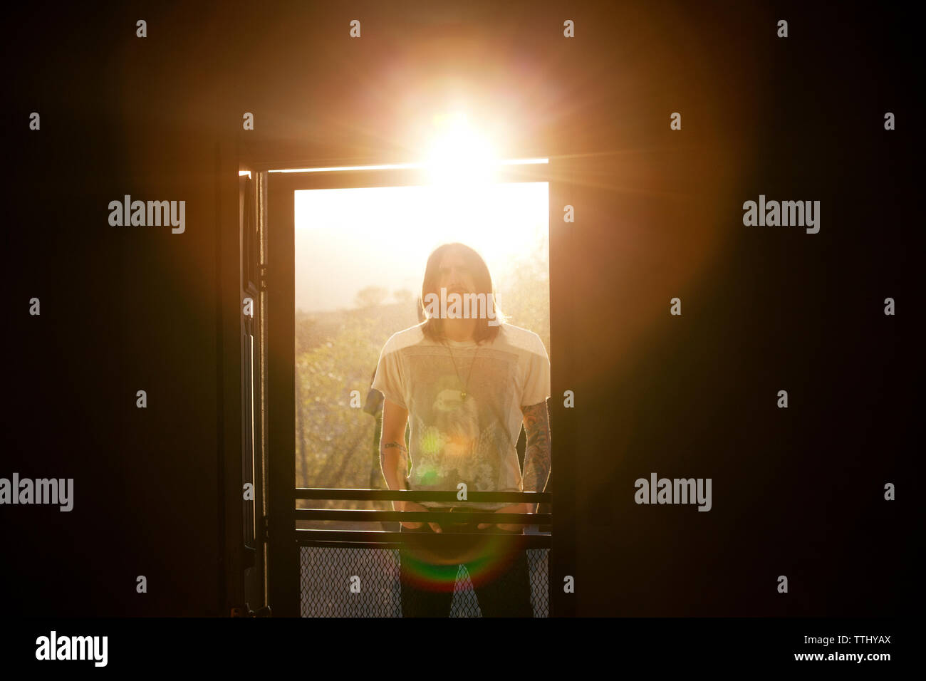 Man standing window hi-res stock photography and images - Alamy
