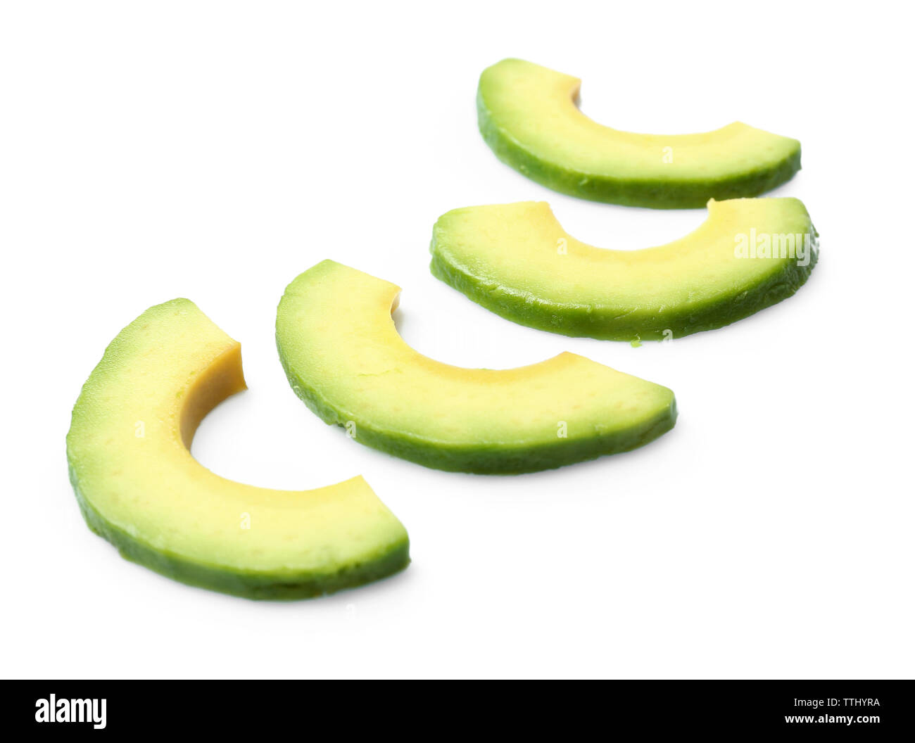 Pieces of avocado isolated on white Stock Photo - Alamy