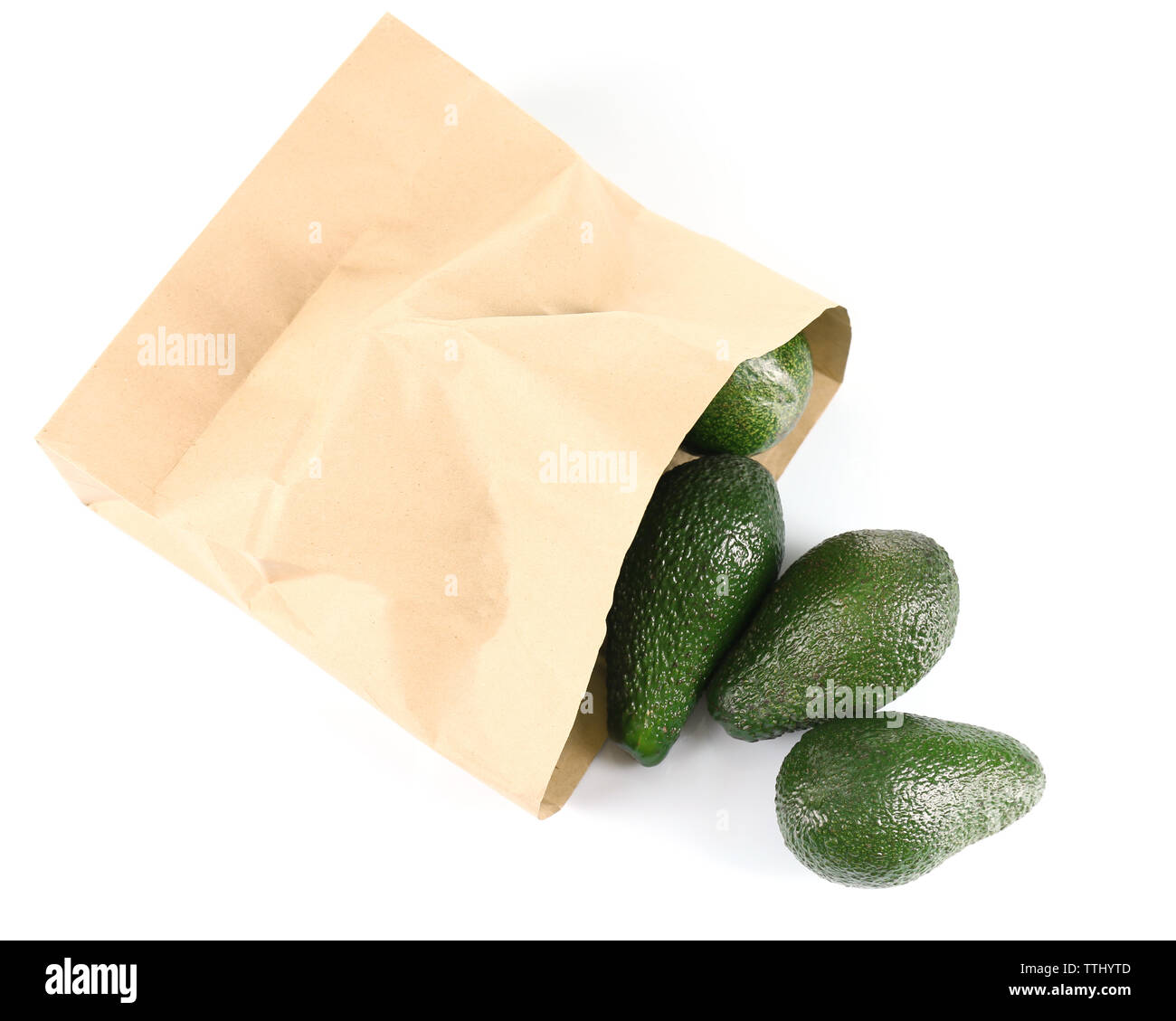 Fresh avocados in paper bag isolated on white Stock Photo - Alamy