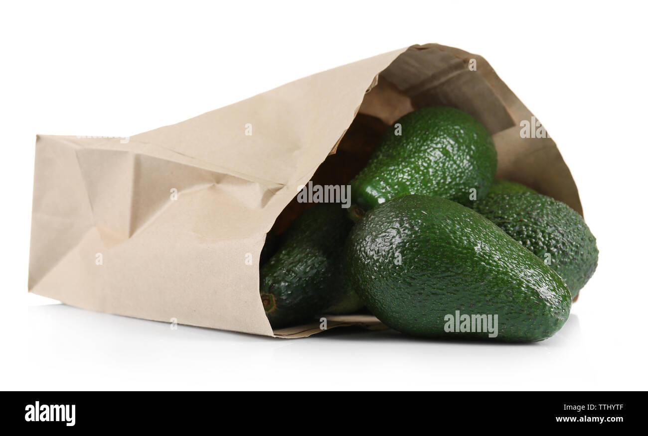 Fresh avocados in paper bag isolated on white Stock Photo - Alamy