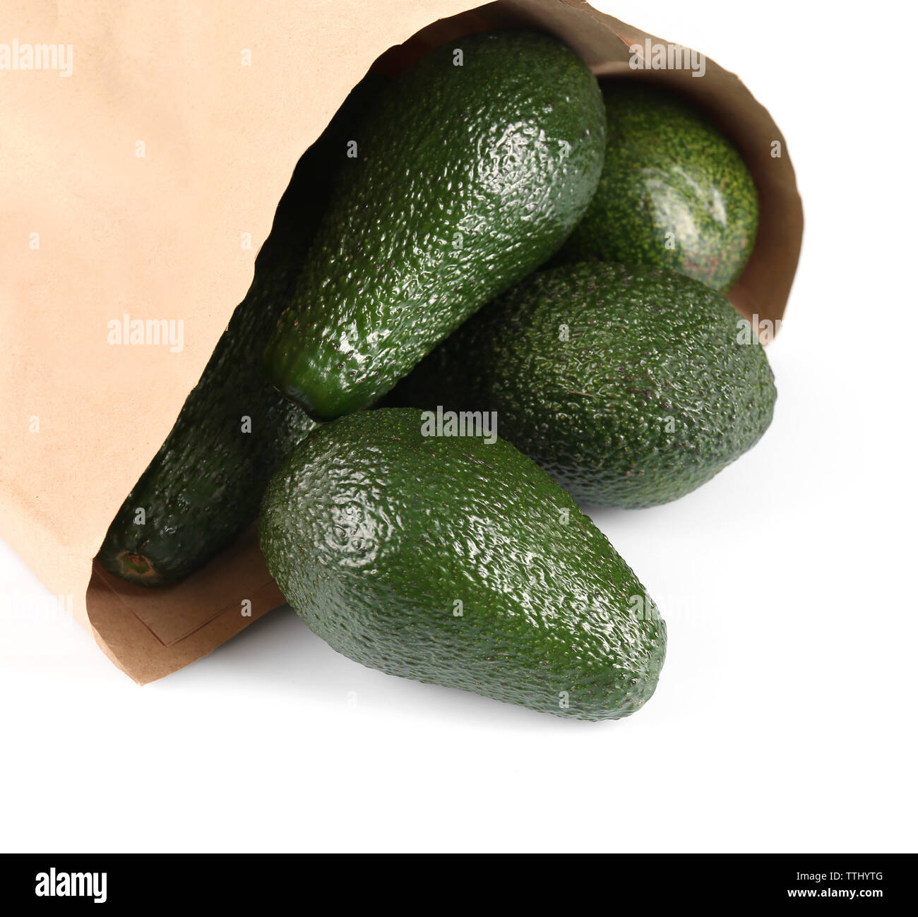 Fresh avocados in paper bag isolated on white Stock Photo - Alamy