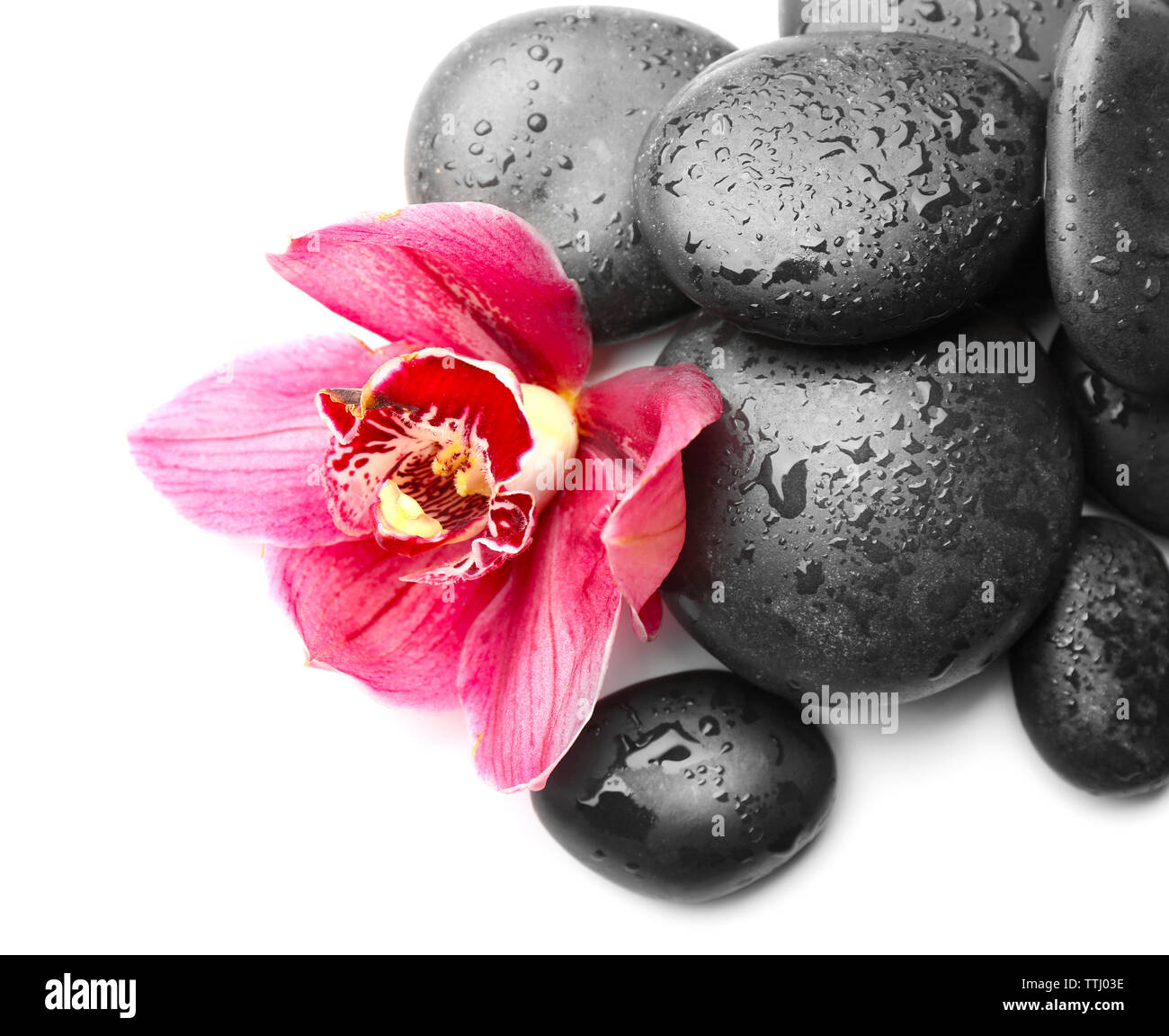 Spa stones and red orchid isolated on white Stock Photo - Alamy