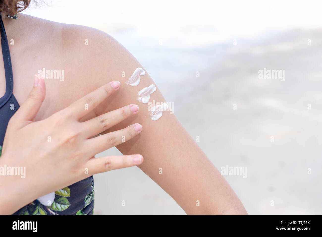 Outdoor summer portrait of Young Asian tan woman wearing bikini sitting ...