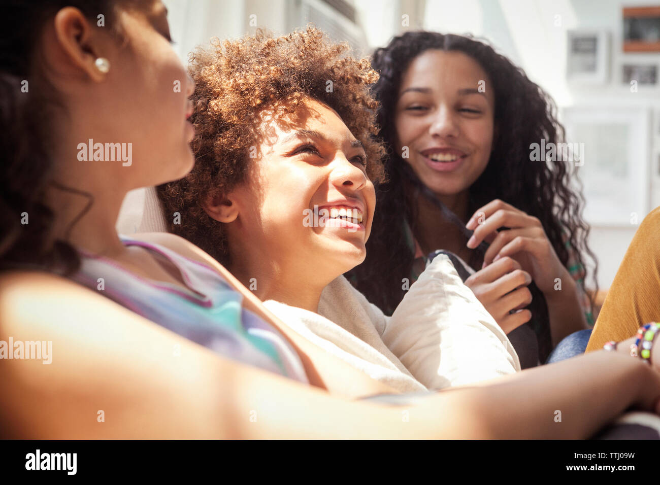Happy siblings sitting on sofa at home Stock Photo - Alamy