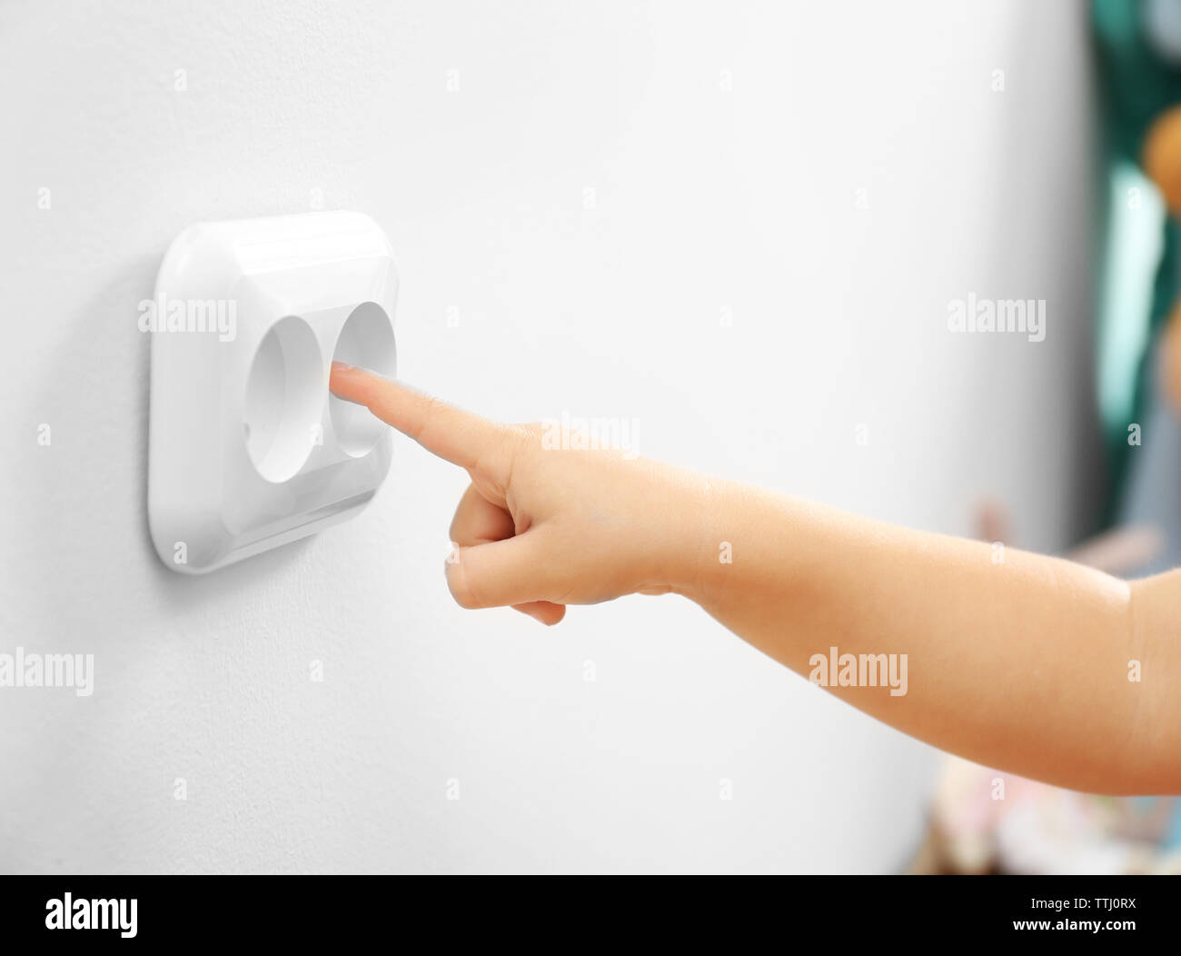 Little child putting finger in power socket, closeup Stock Photo - Alamy