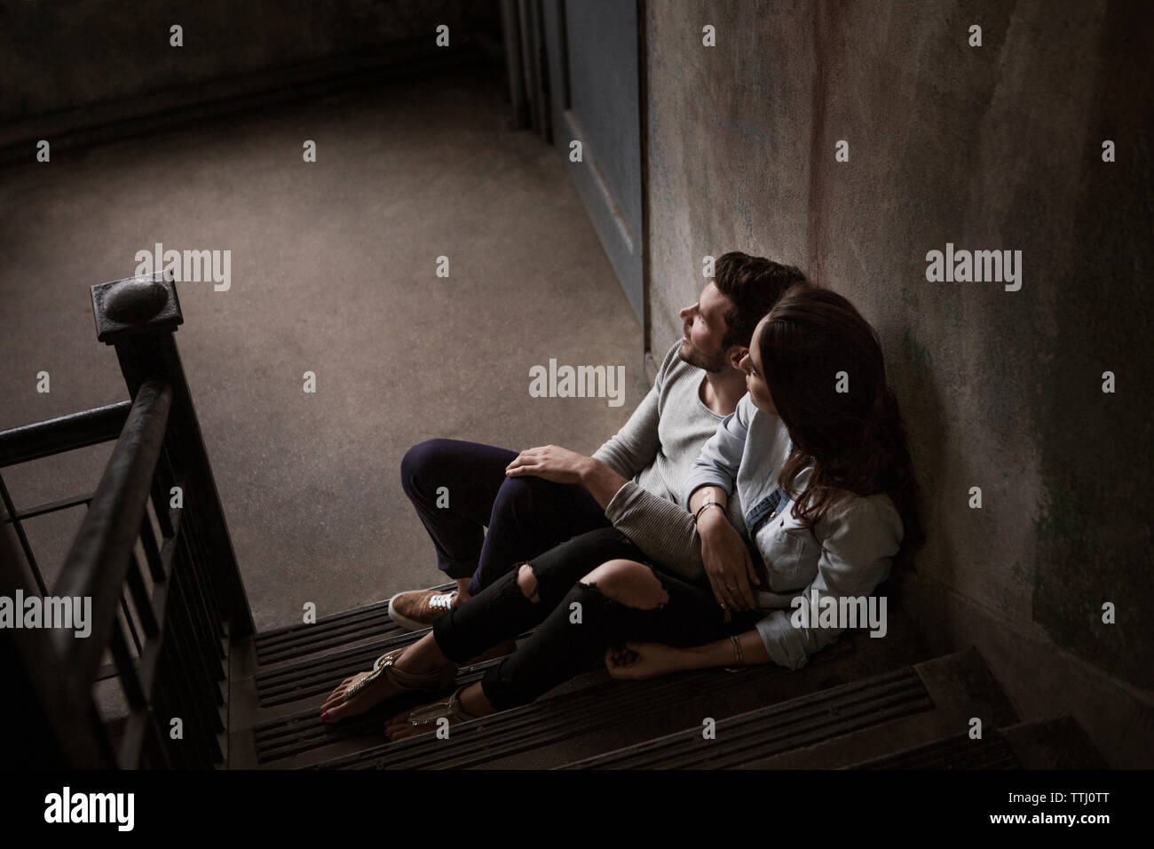 Two people sitting on stairs hi-res stock photography and images - Alamy