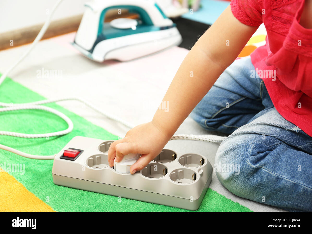 Little girl playing with electric power bar in the kid's room Stock ...