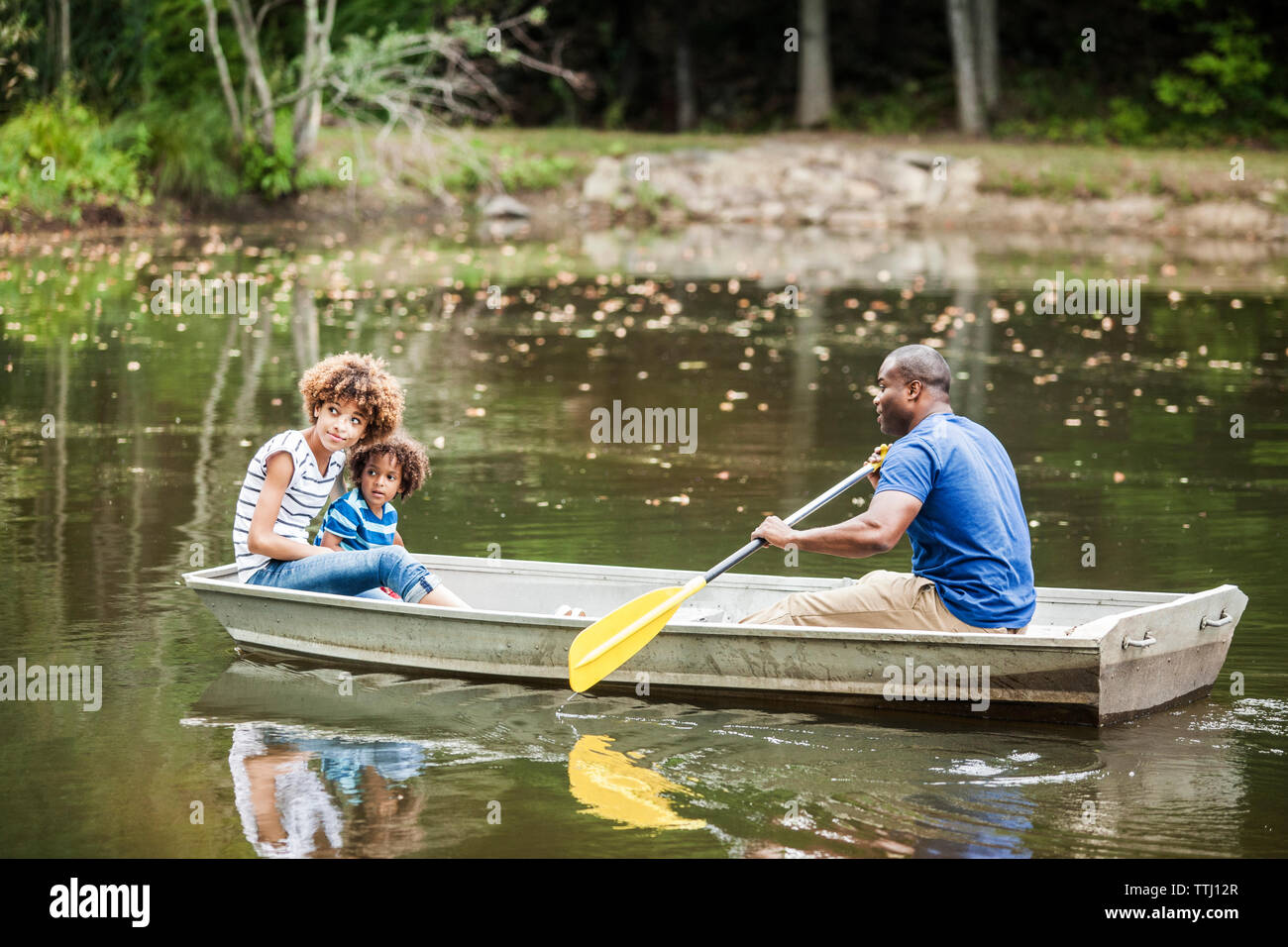Father and children boating in lake Stock Photo - Alamy
