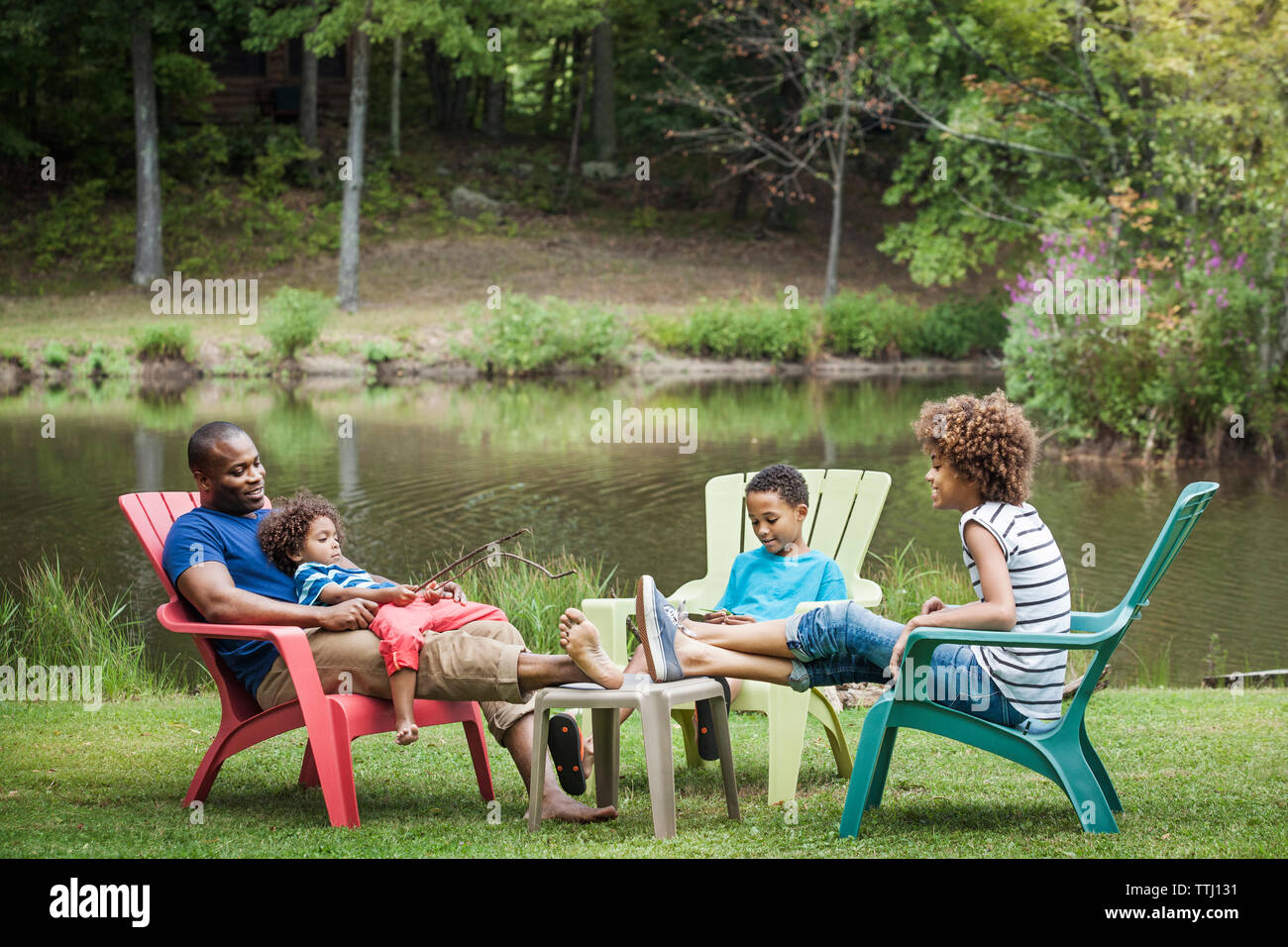 Four People Sitting On Chairs High Resolution Stock Photography and ...