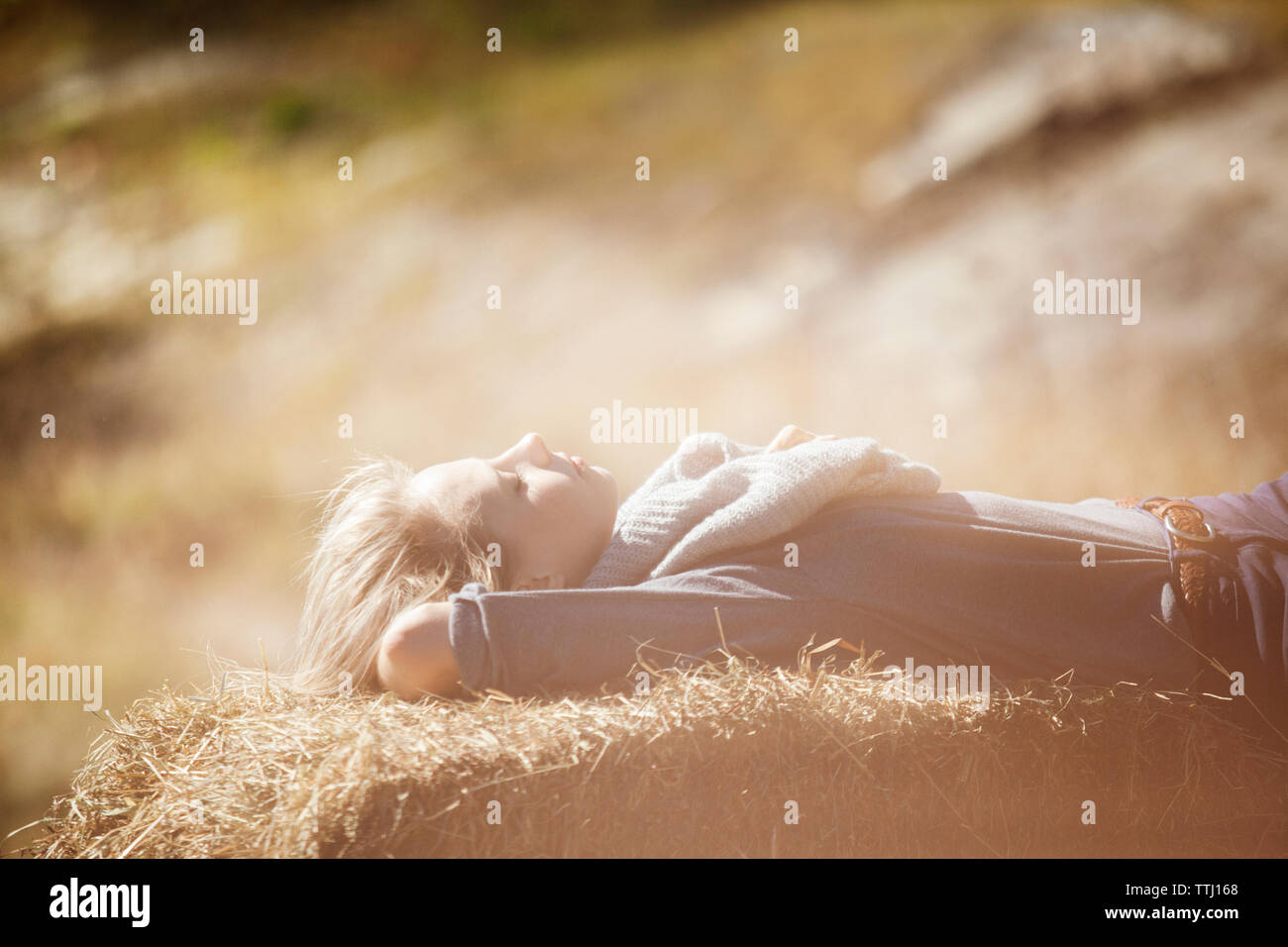 Woman sleeping on hay at farm Stock Photo - Alamy