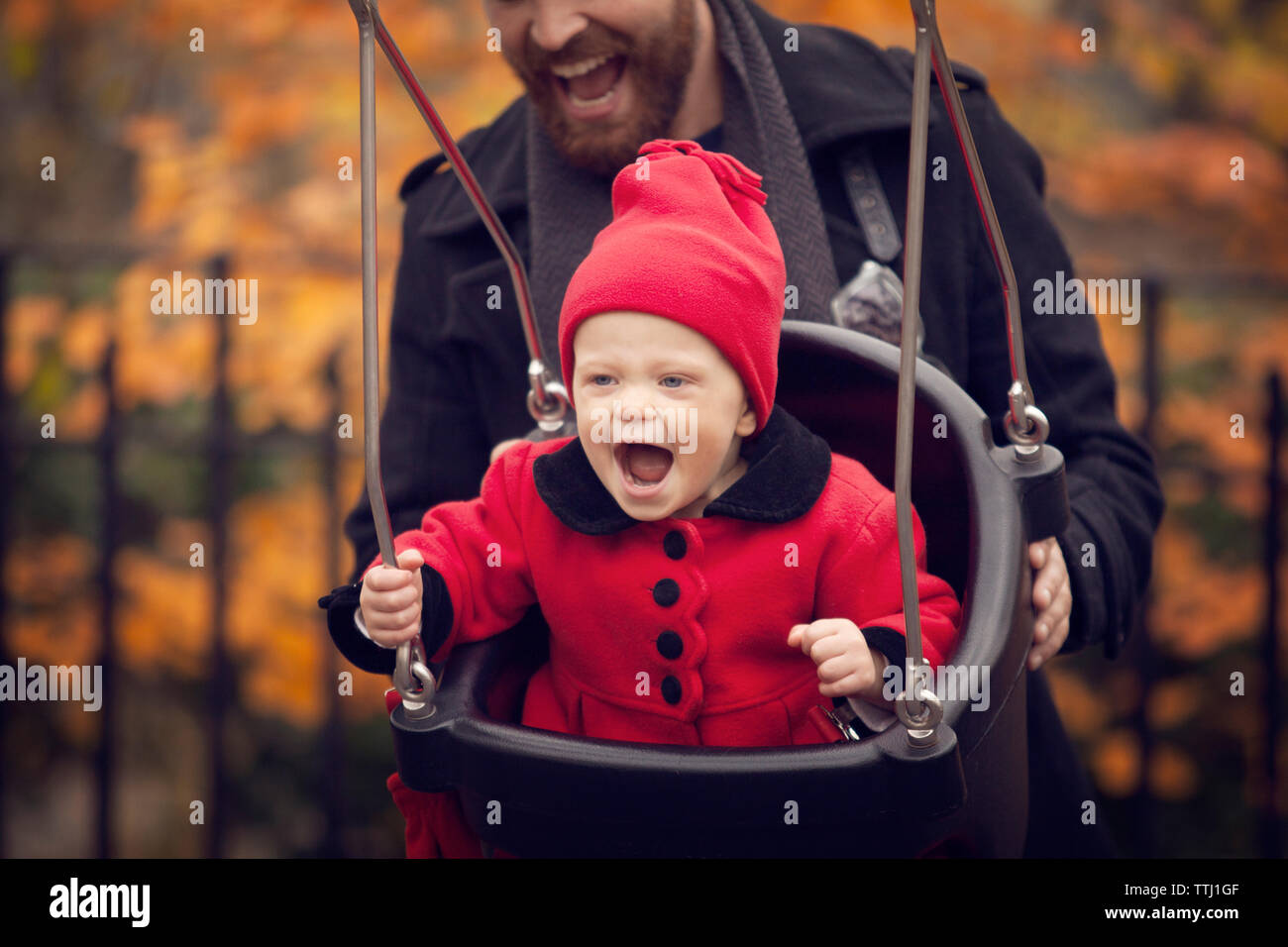 Pushing swing hi-res stock photography and images - Alamy