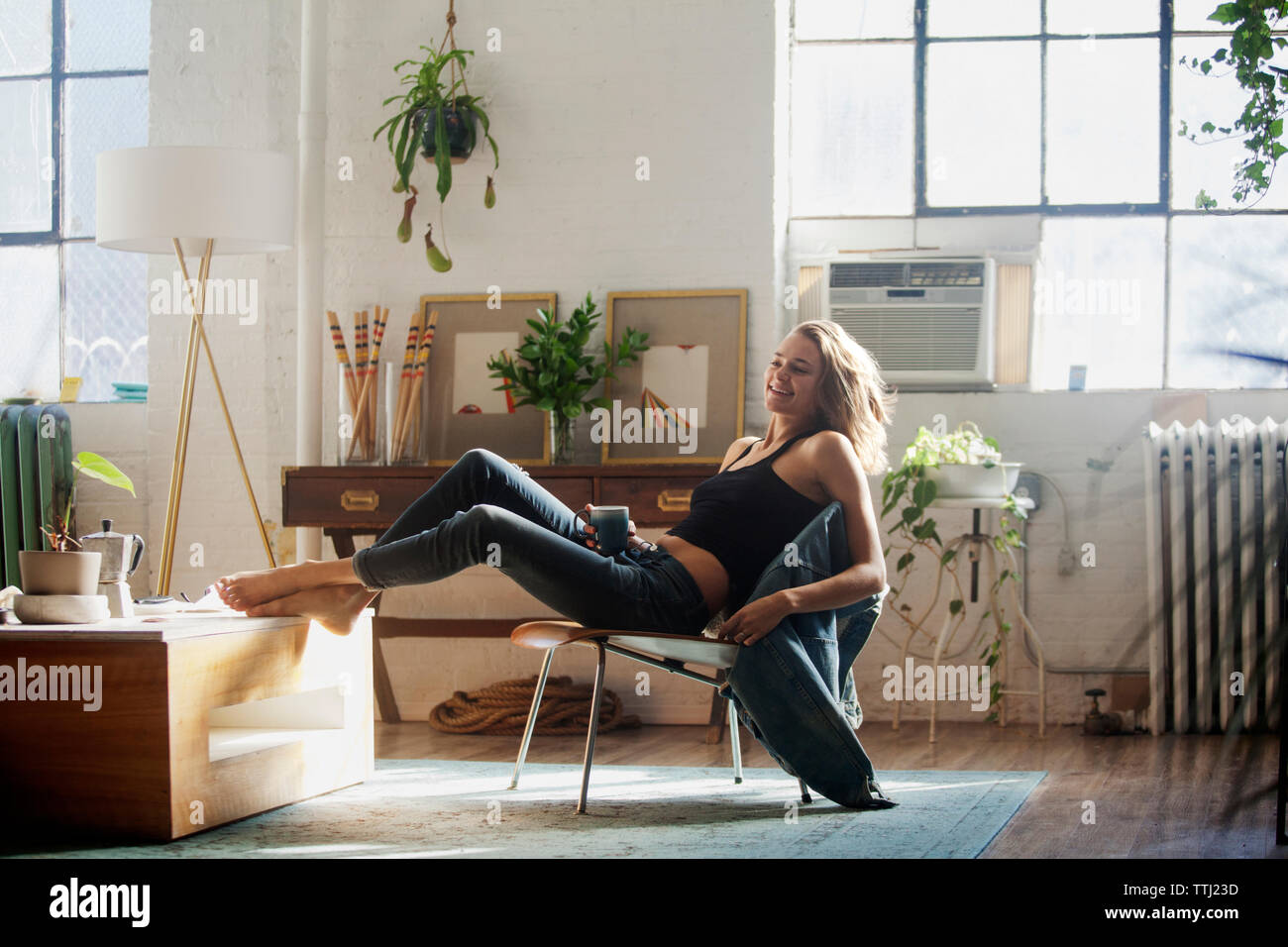 Feet up on chair hi-res stock photography and images - Alamy