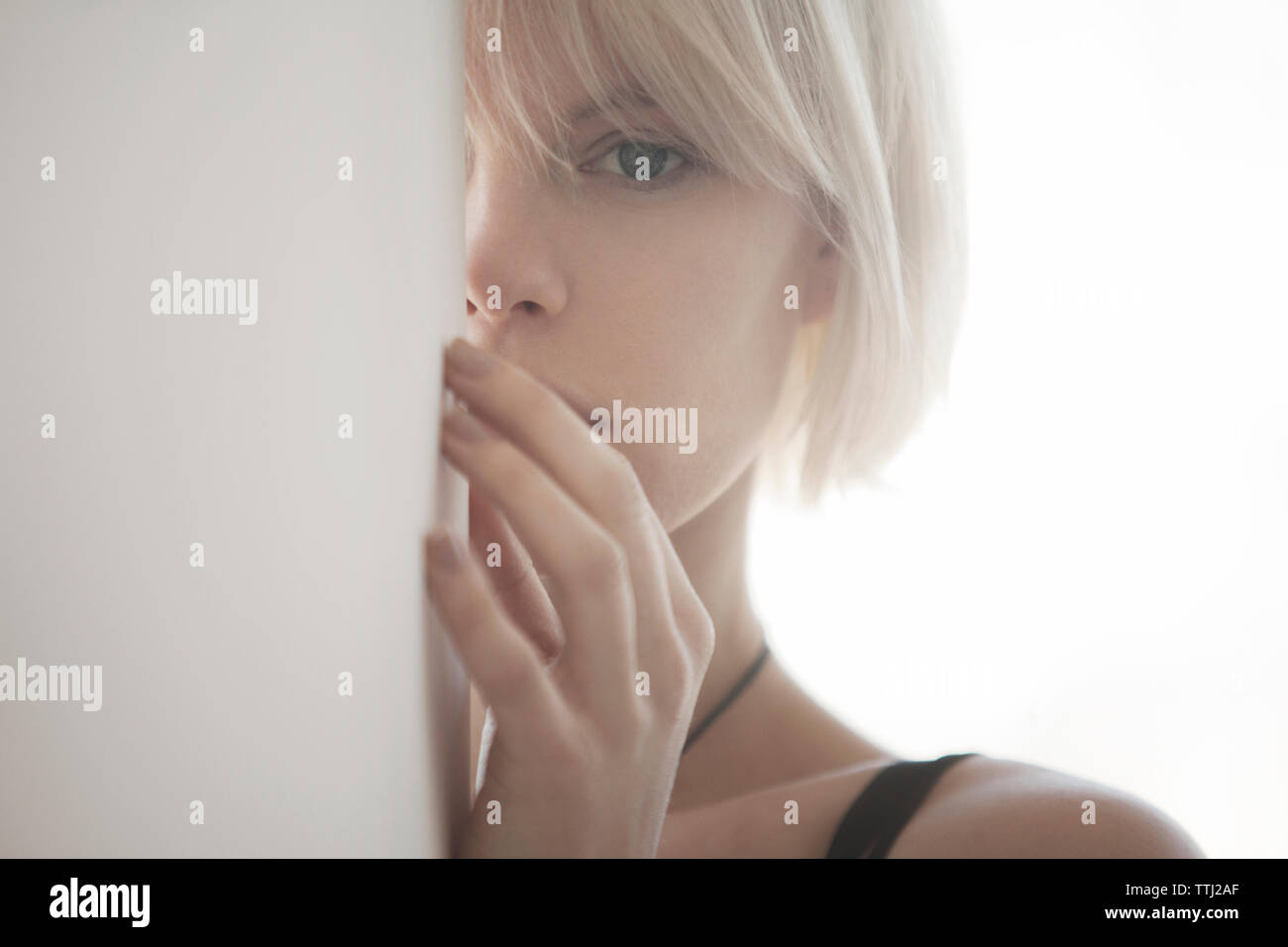 Hiding behind wall hi-res stock photography and images - Alamy