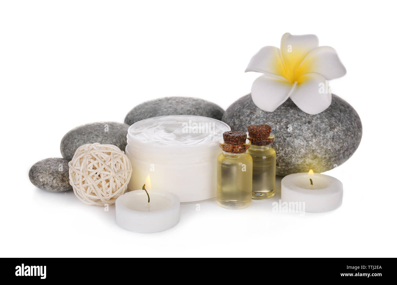 Spa treatment with stones and cream isolated on white Stock Photo - Alamy