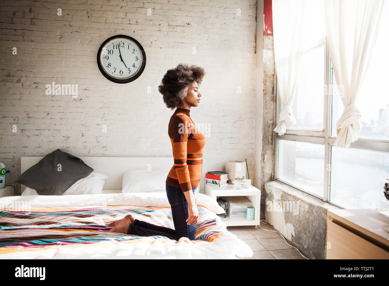 Woman Kneeling On Bed