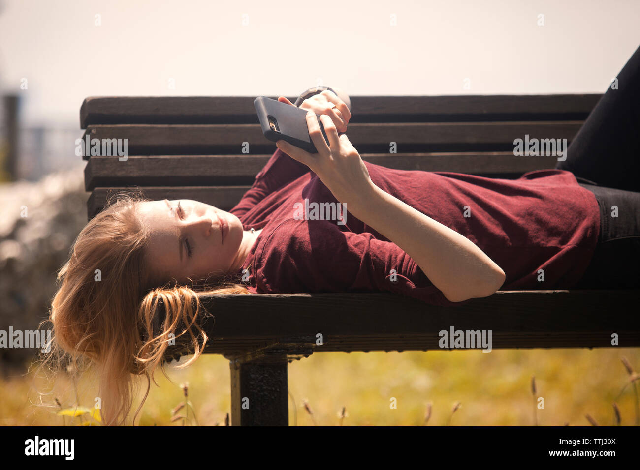 Female lying down on bench hi-res stock photography and images - Alamy