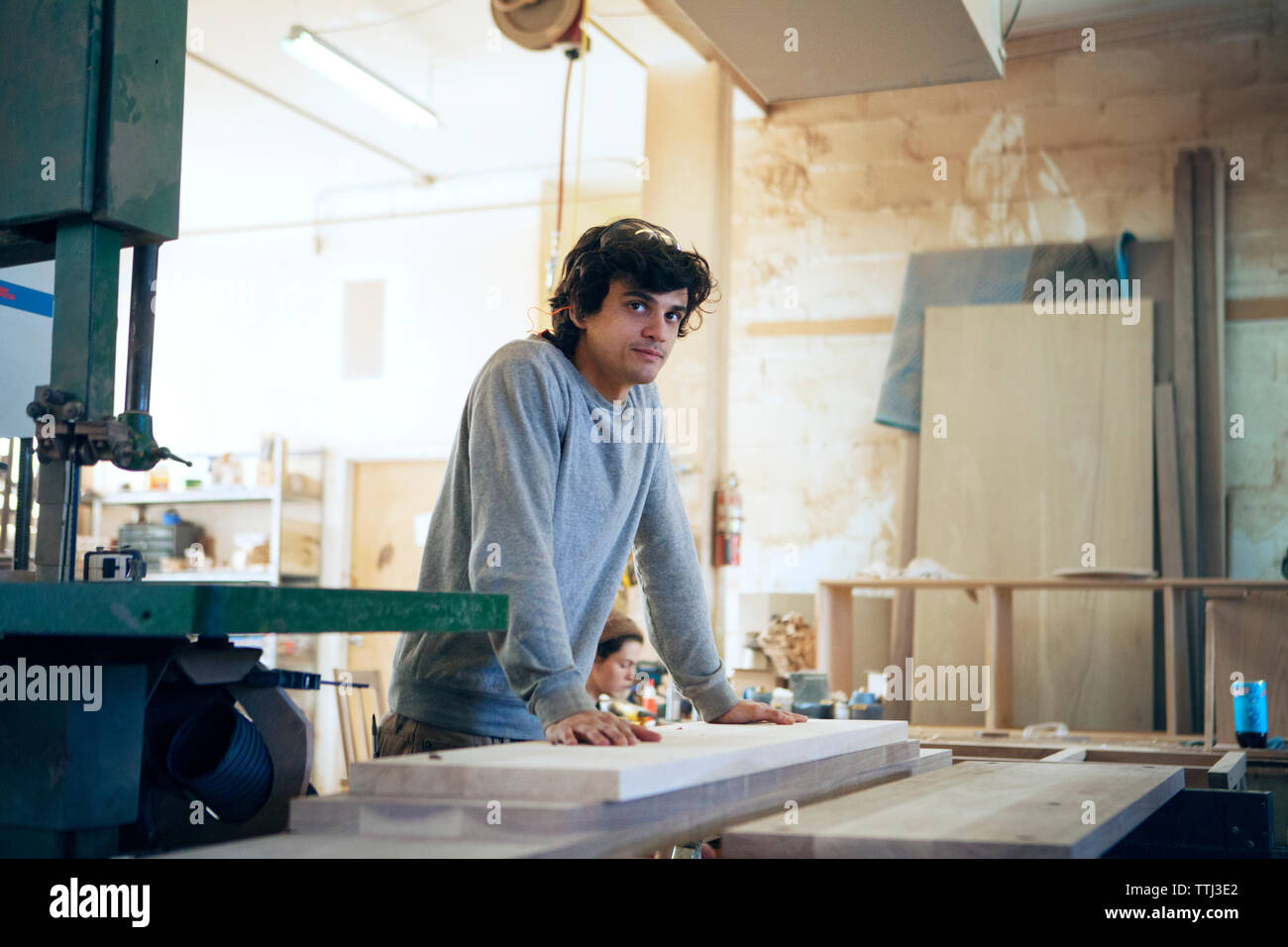 Thoughtful carpenter standing at workbench Stock Photo - Alamy