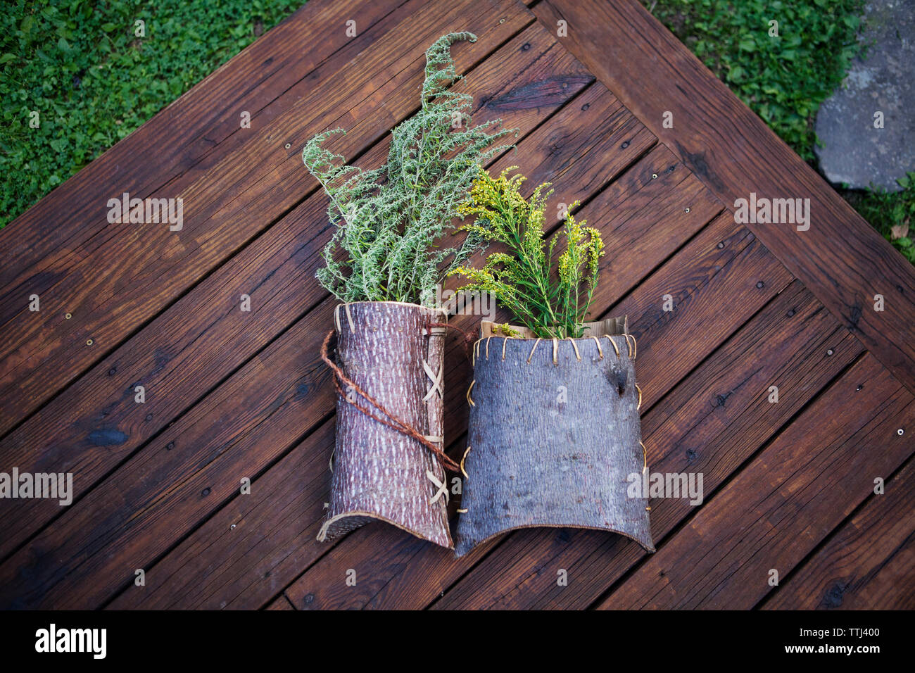 Overhead view of basket with plants on wooden table Stock Photo - Alamy