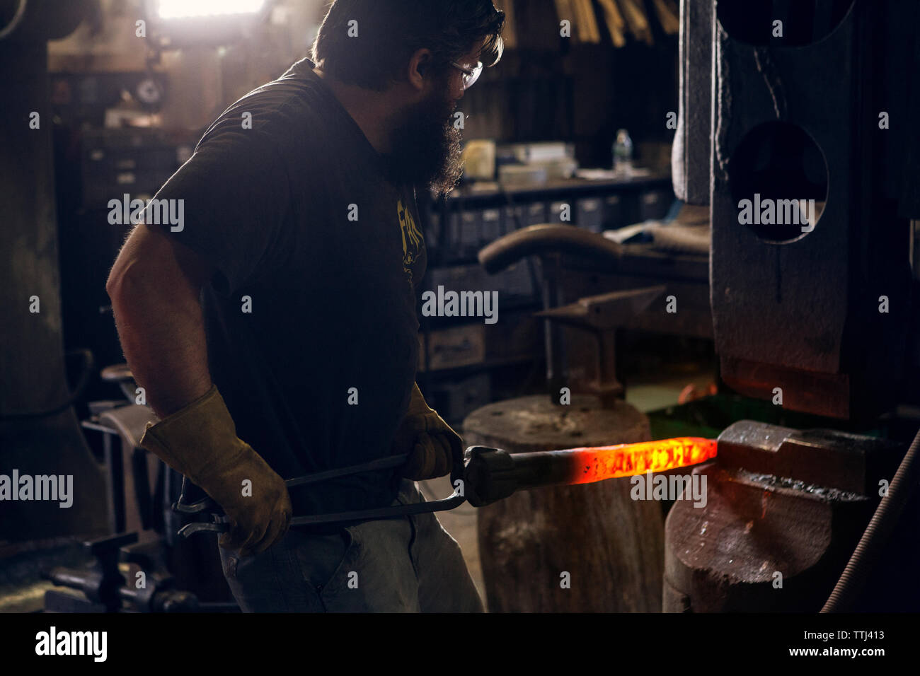 Blacksmith forging rod at workshop Stock Photo - Alamy