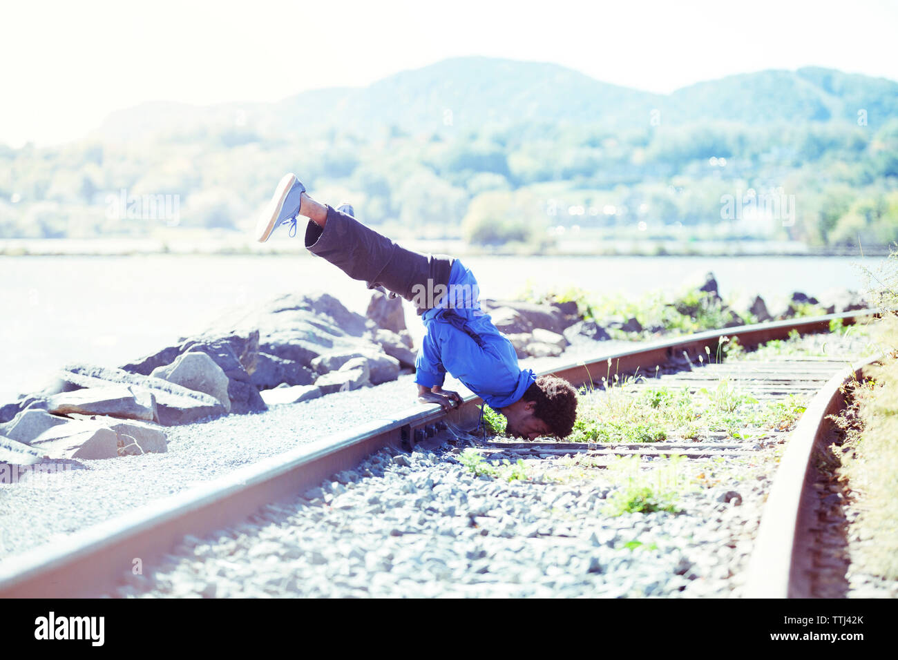 Man exercising on railroad track Stock Photo - Alamy