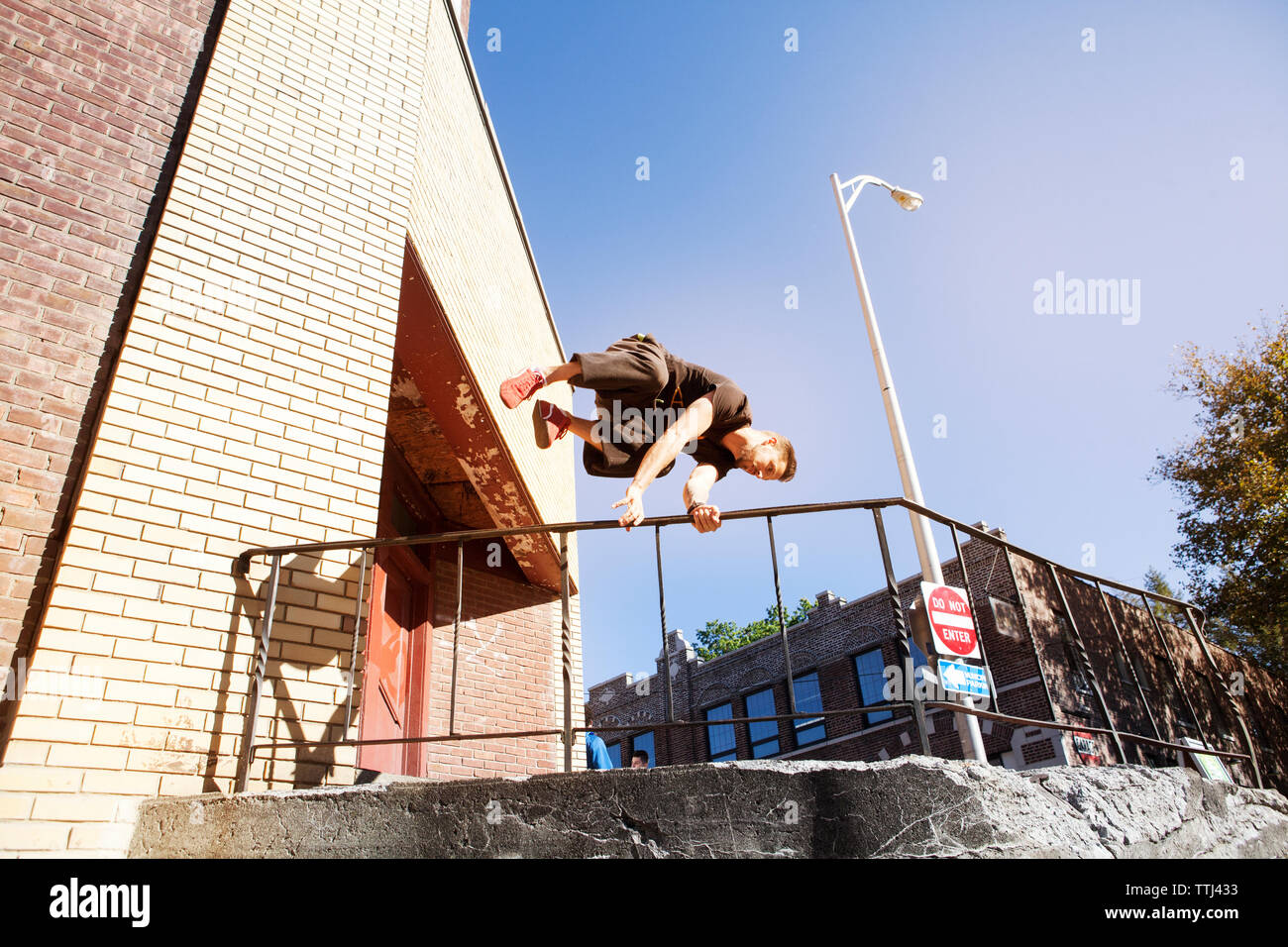 Young man jumping over railing hi-res stock photography and images - Alamy