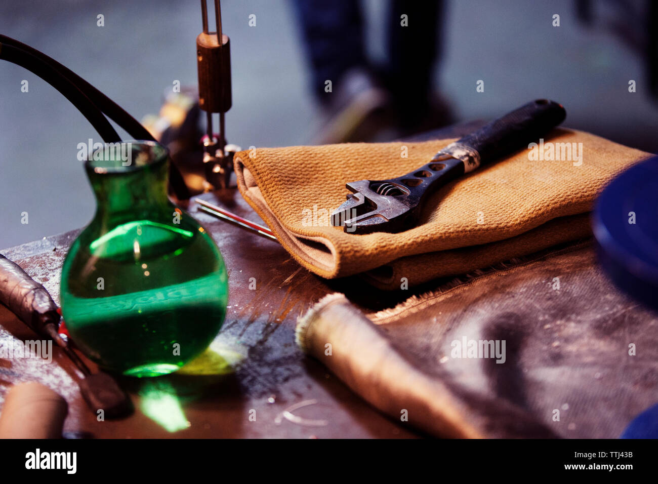 Work tools with flask on wooden table at workshop Stock Photo - Alamy