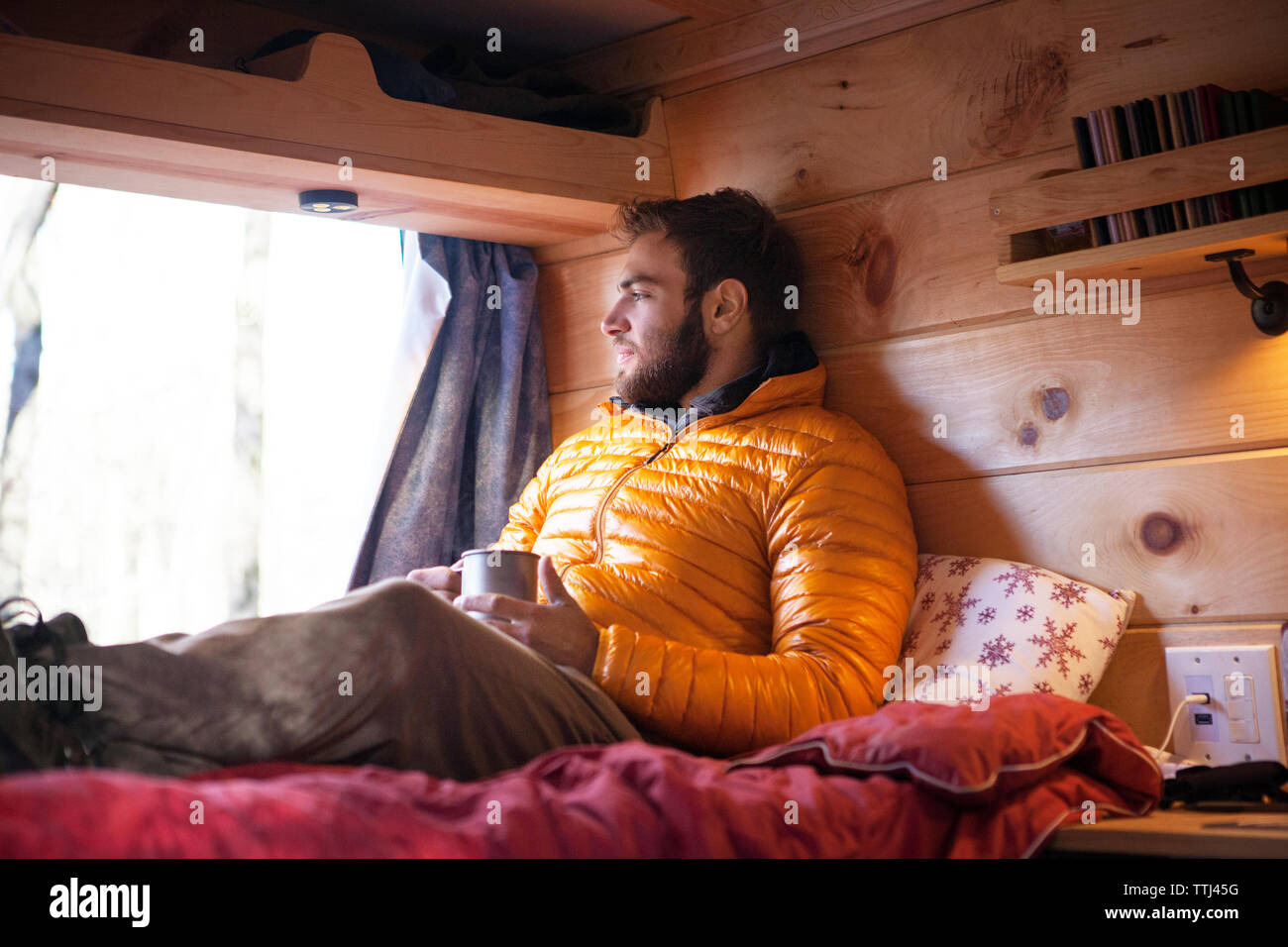 Thoughtful man relaxing in camper van Stock Photo - Alamy