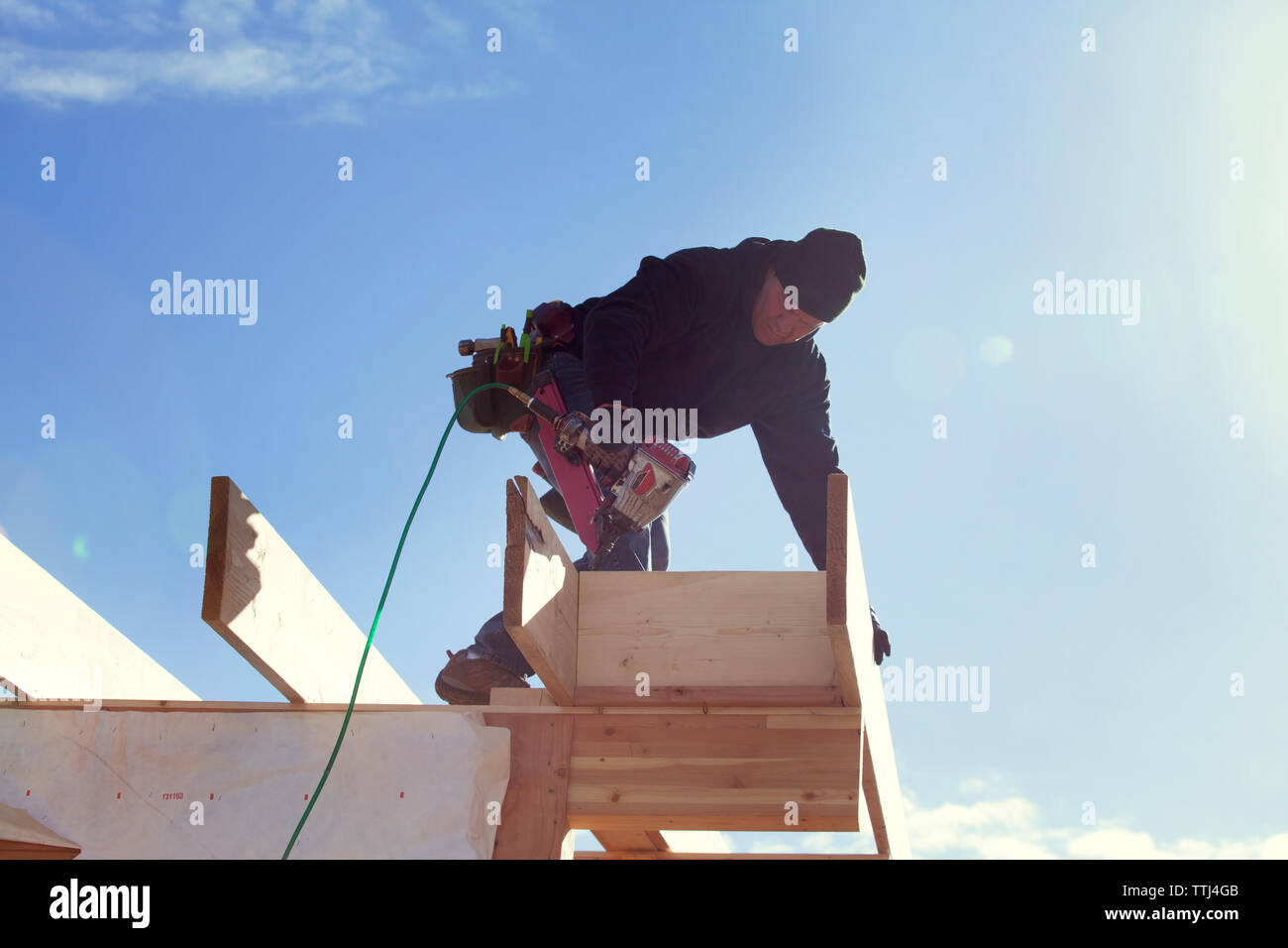 Man standing on roof beam hi-res stock photography and images - Alamy