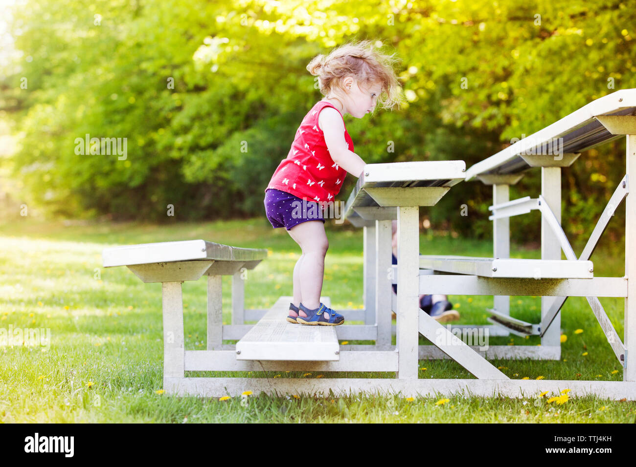 Girl on park bench hi-res stock photography and images - Alamy
