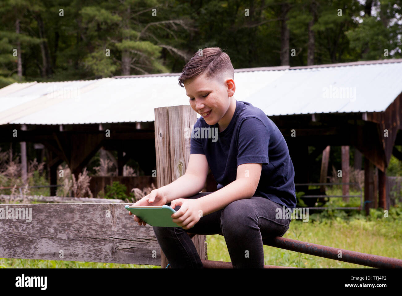 Boy on gate hi-res stock photography and images - Alamy