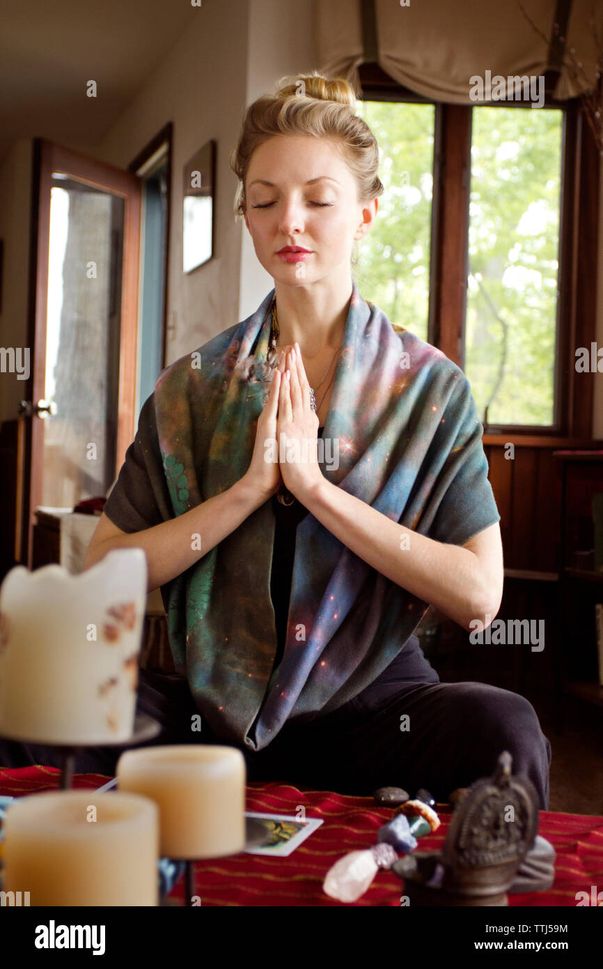 Tarot card reader meditating at home Stock Photo - Alamy