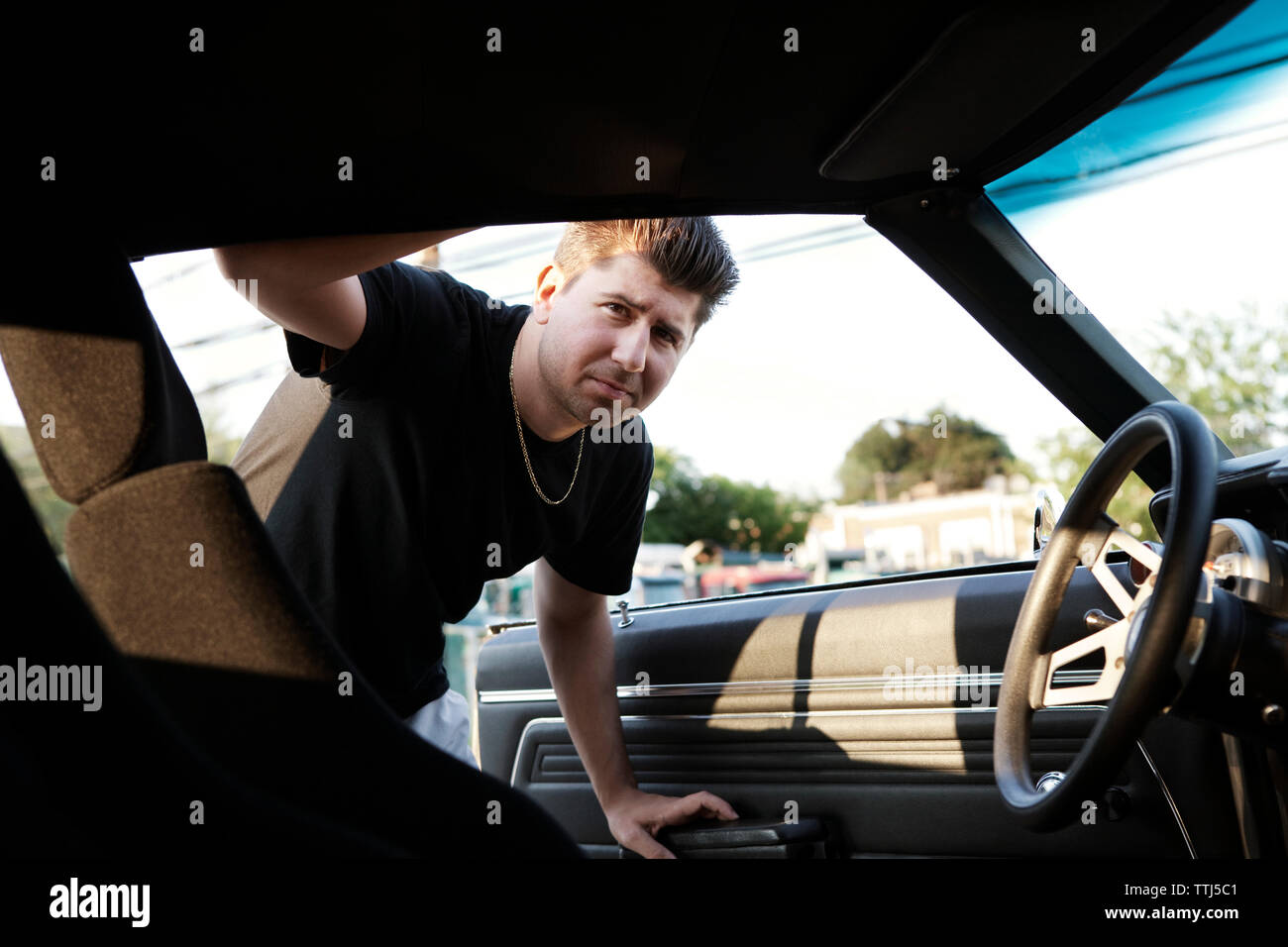 Man looking in car Stock Photo - Alamy