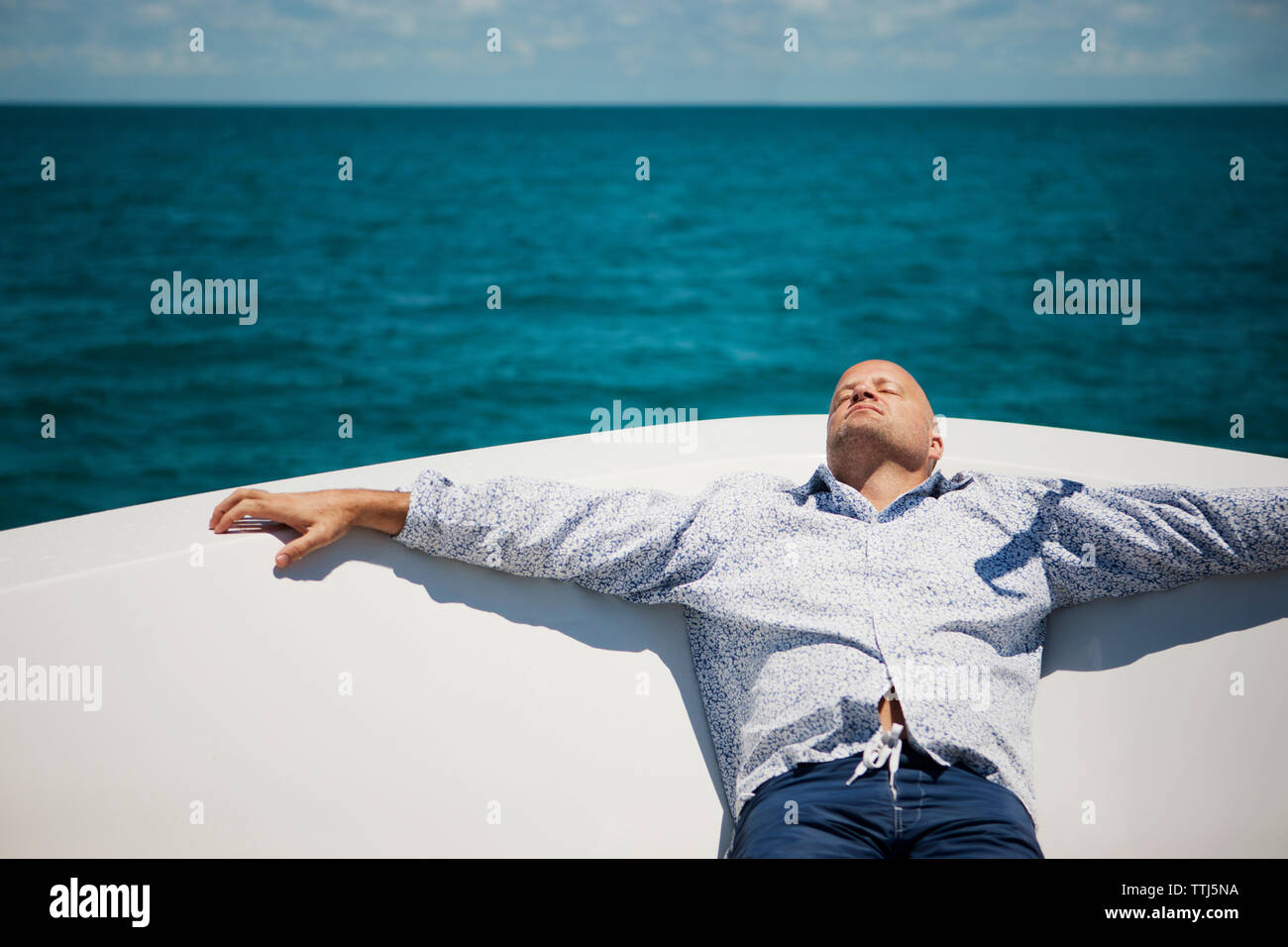 Man relaxing on deck of yacht Stock Photo - Alamy