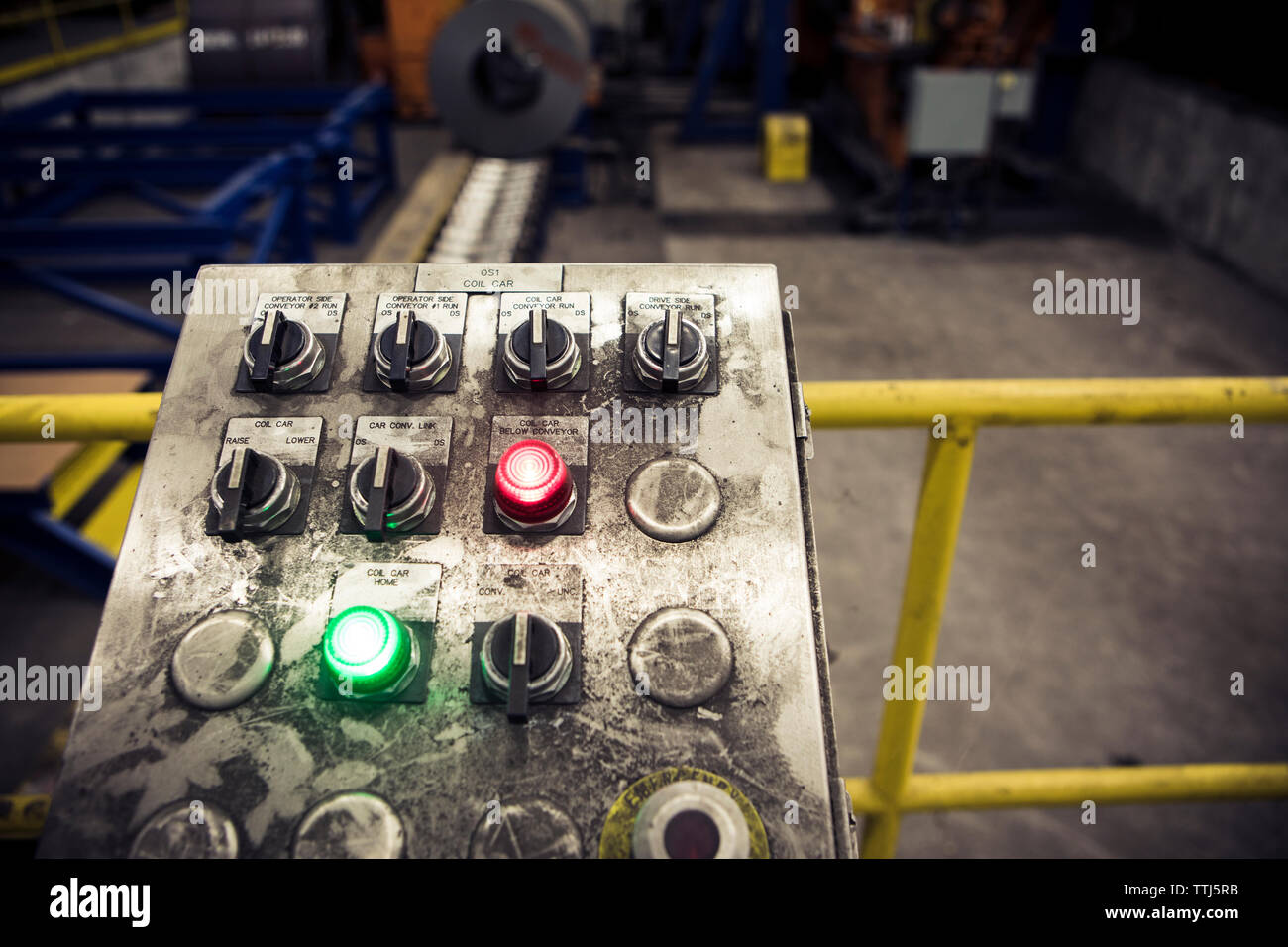 High angle view of buttons on messy control panel at metal industry ...