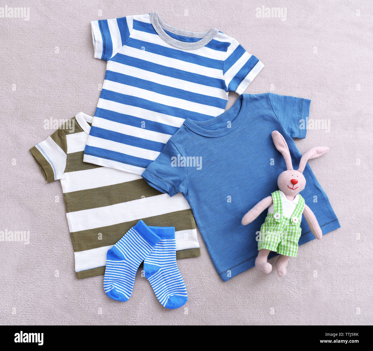 Baby clothes on fabric background Stock Photo - Alamy