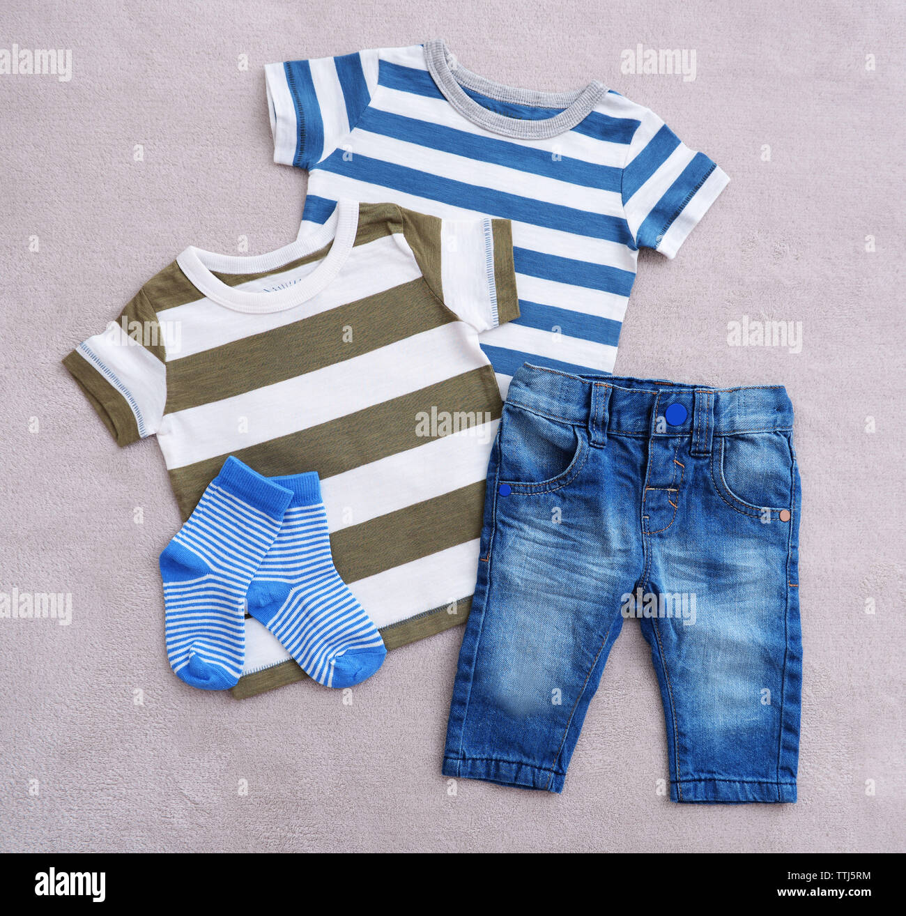 Baby clothes on fabric background Stock Photo - Alamy