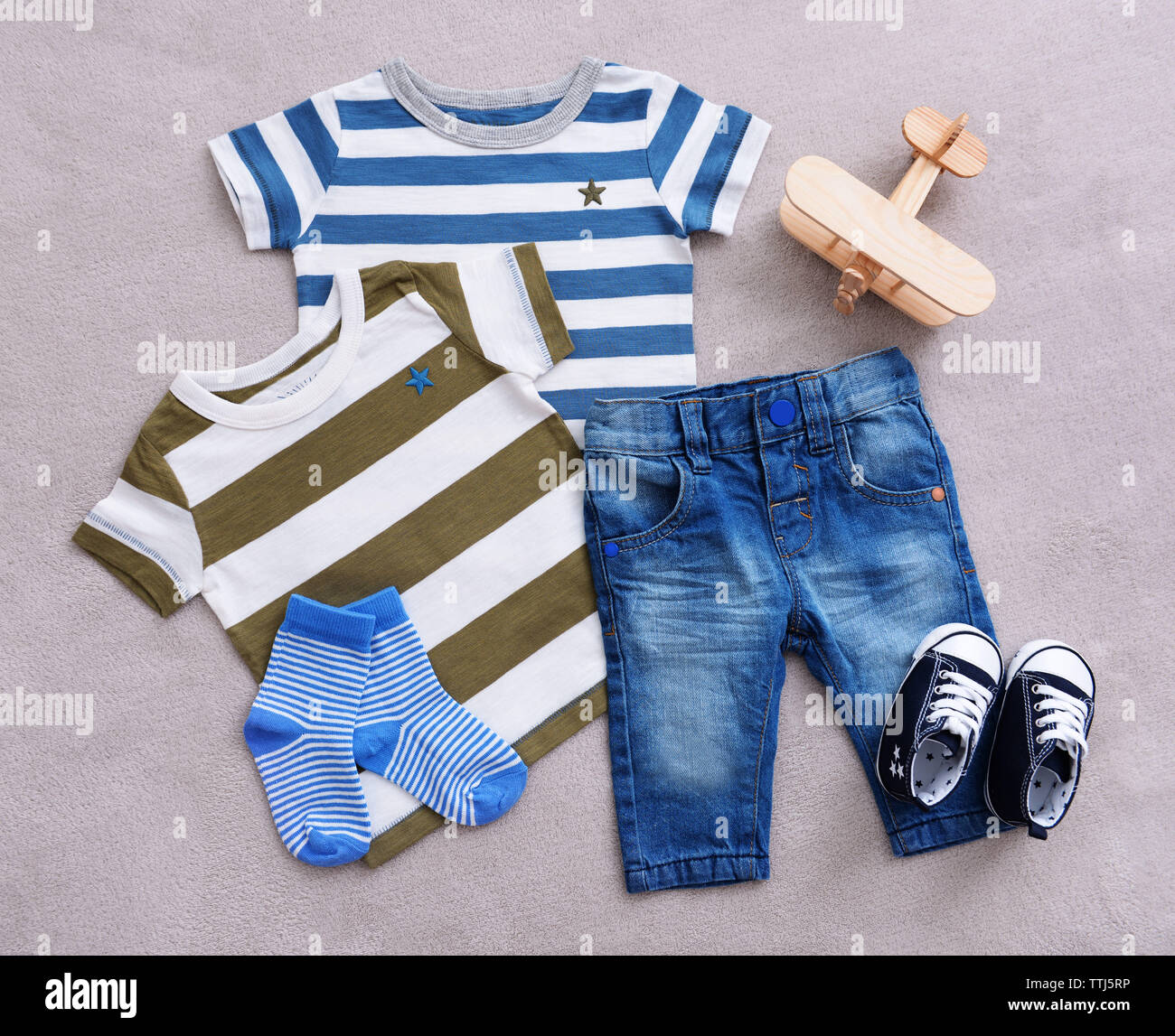 Baby clothes on fabric background Stock Photo - Alamy