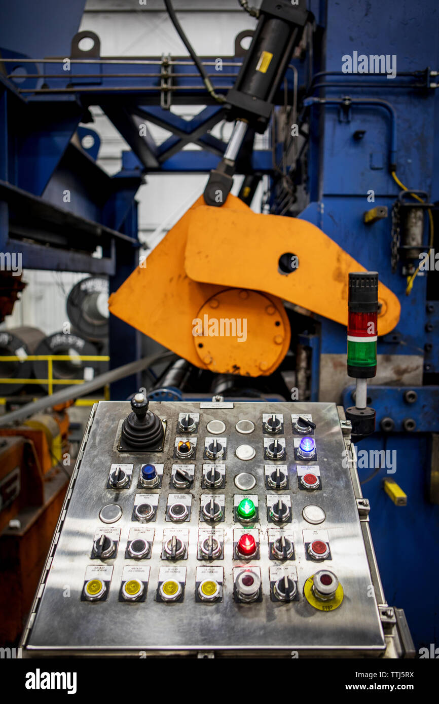 High angle view of control panel against machinery in metal industry ...