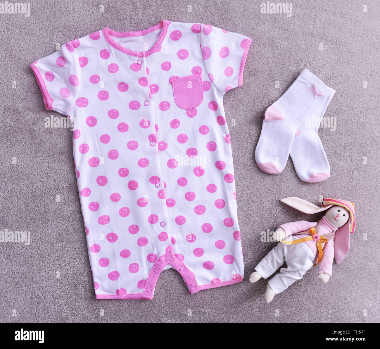 Baby clothes on fabric background Stock Photo - Alamy
