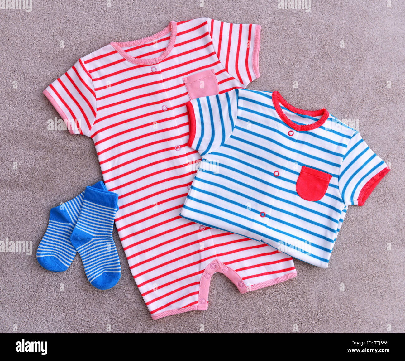 Baby clothes on fabric background Stock Photo - Alamy
