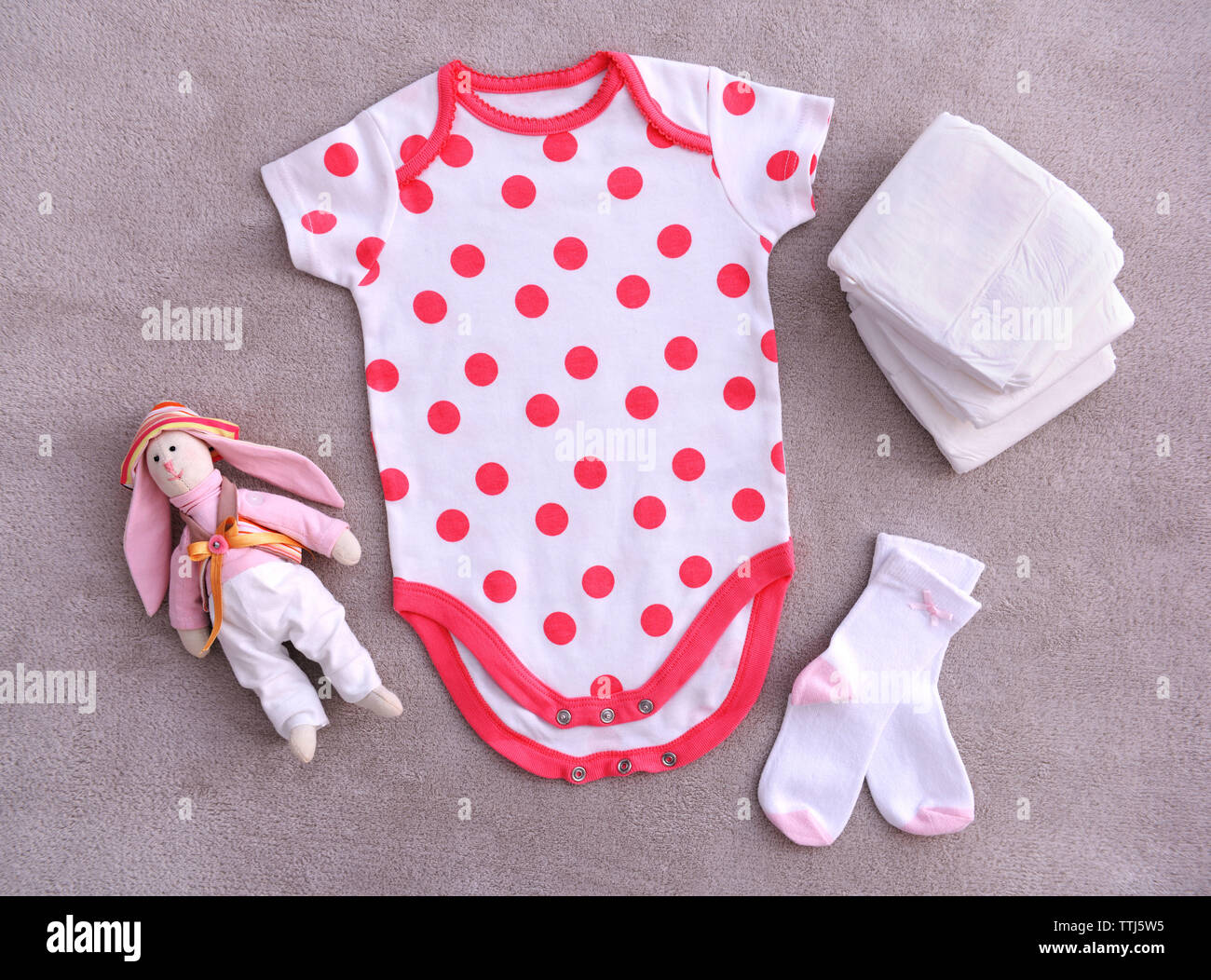 Baby clothes on fabric background Stock Photo - Alamy