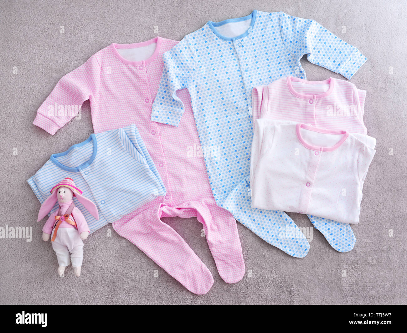 Baby clothes on fabric background Stock Photo - Alamy