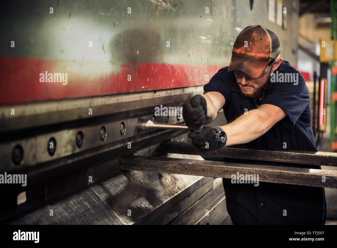 Manual worker using t wrench in metal industry Stock Photo - Alamy